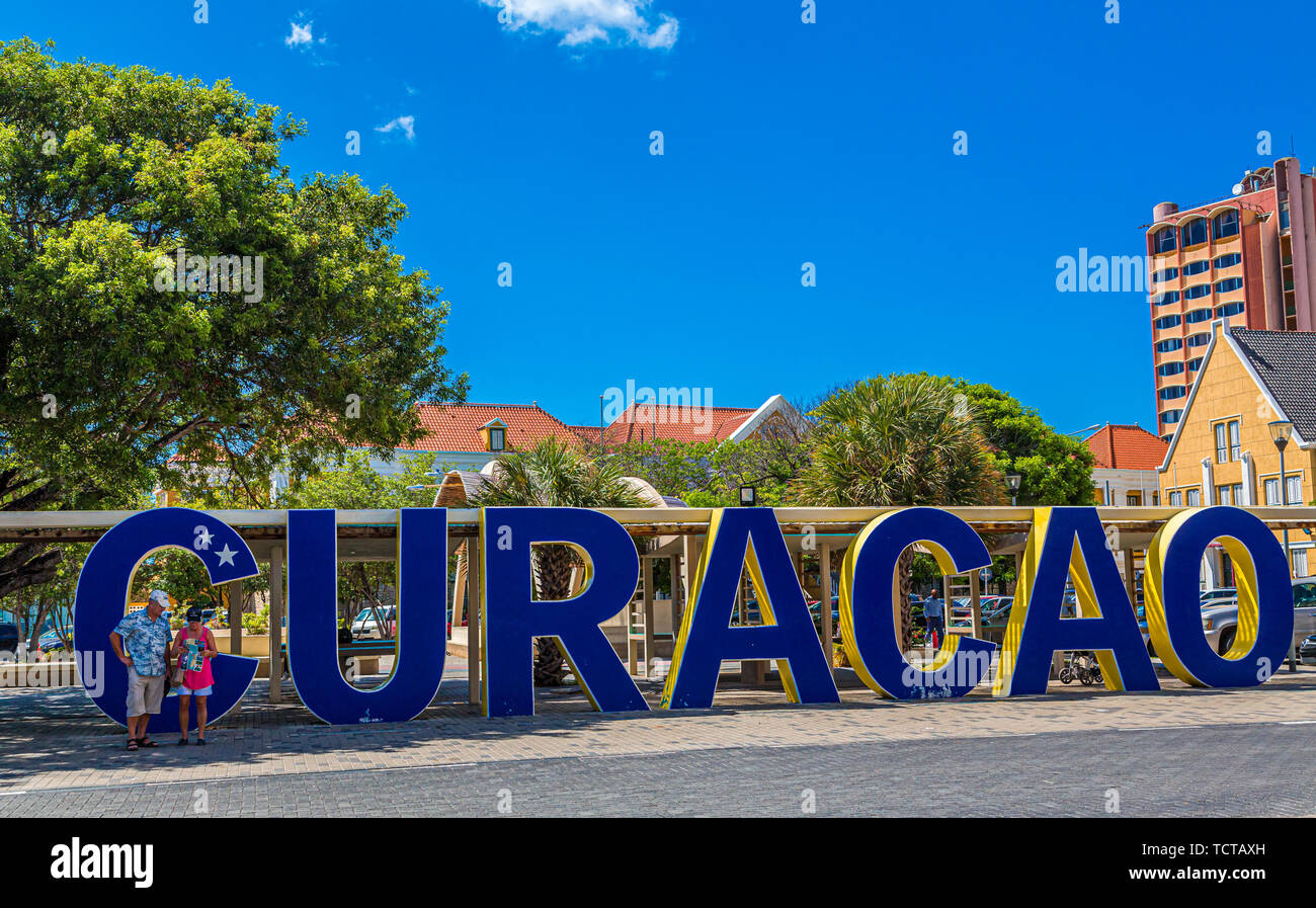 Tourists at Blue Curacao sign in Willemstad Stock Photo - Alamy