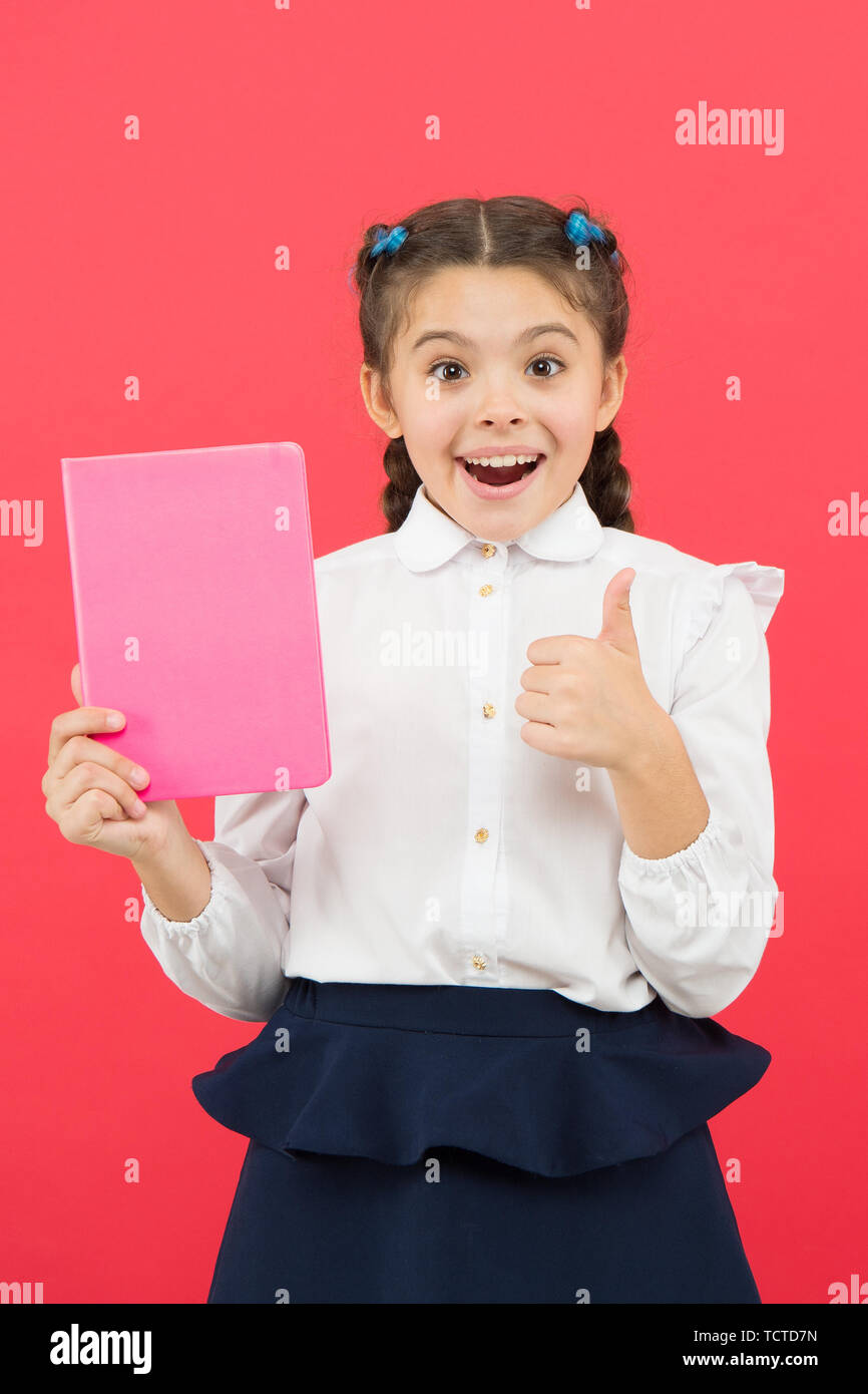 Liking her idea. Happy schoolgirl got main idea of book. Adorable ...