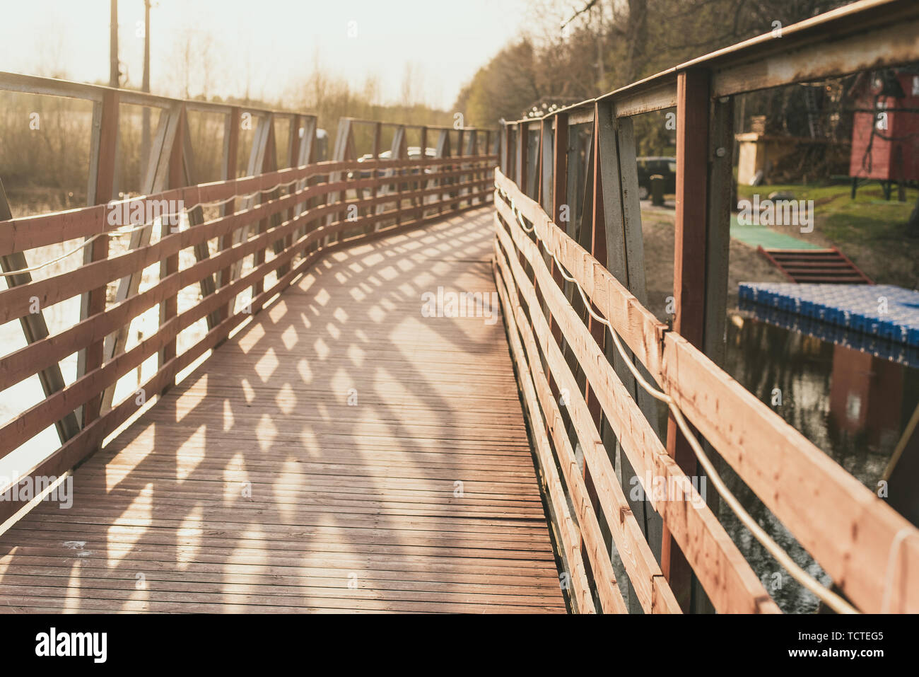 wooden bridge on the river. sunset sun on the background. Rustic style ...