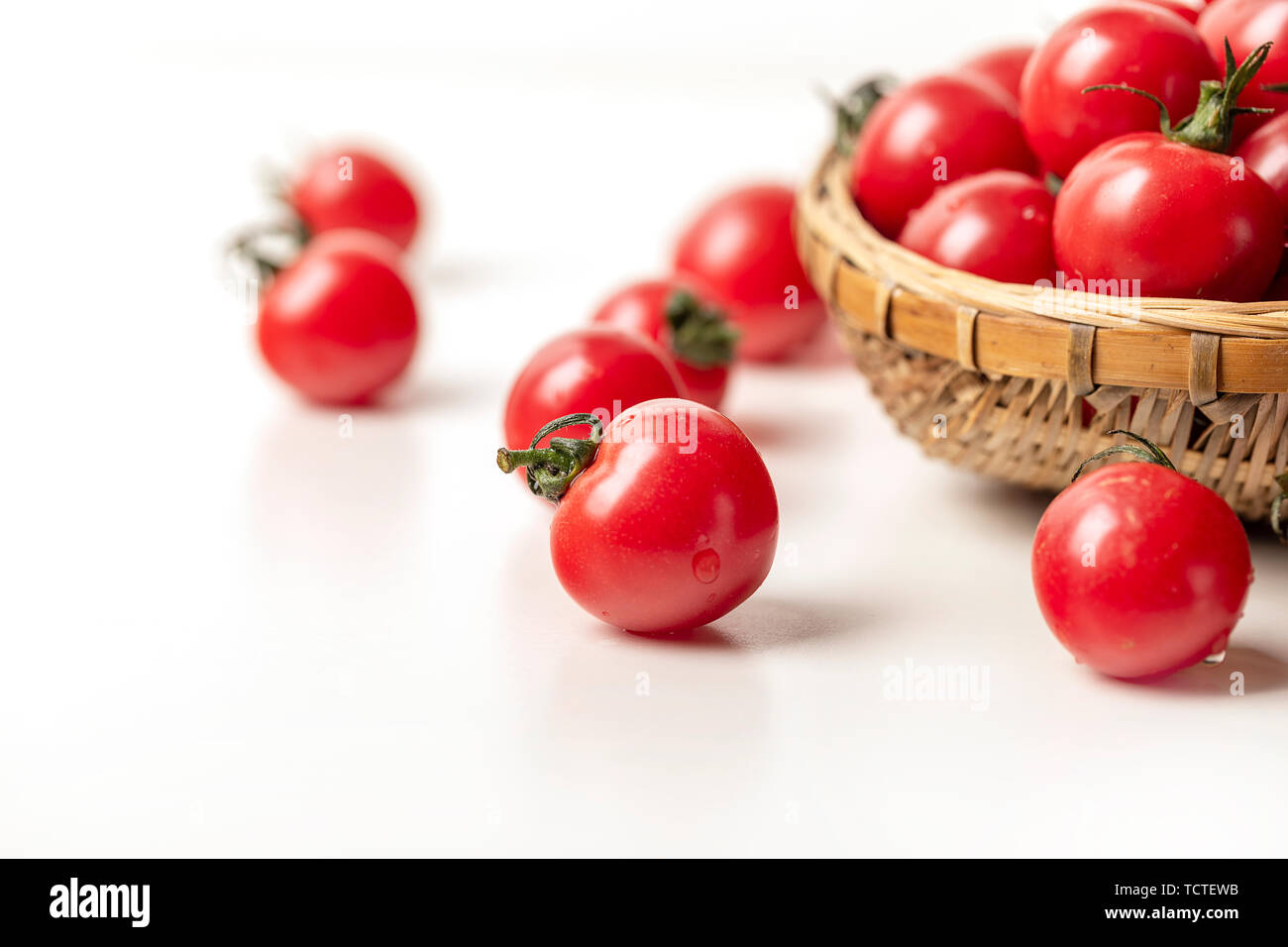 Tomatoes on a white background, sage fruit Stock Photo - Alamy