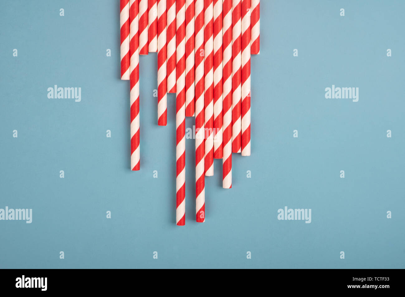 Red eco-friendly paper straw on light blue background Stock Photo - Alamy