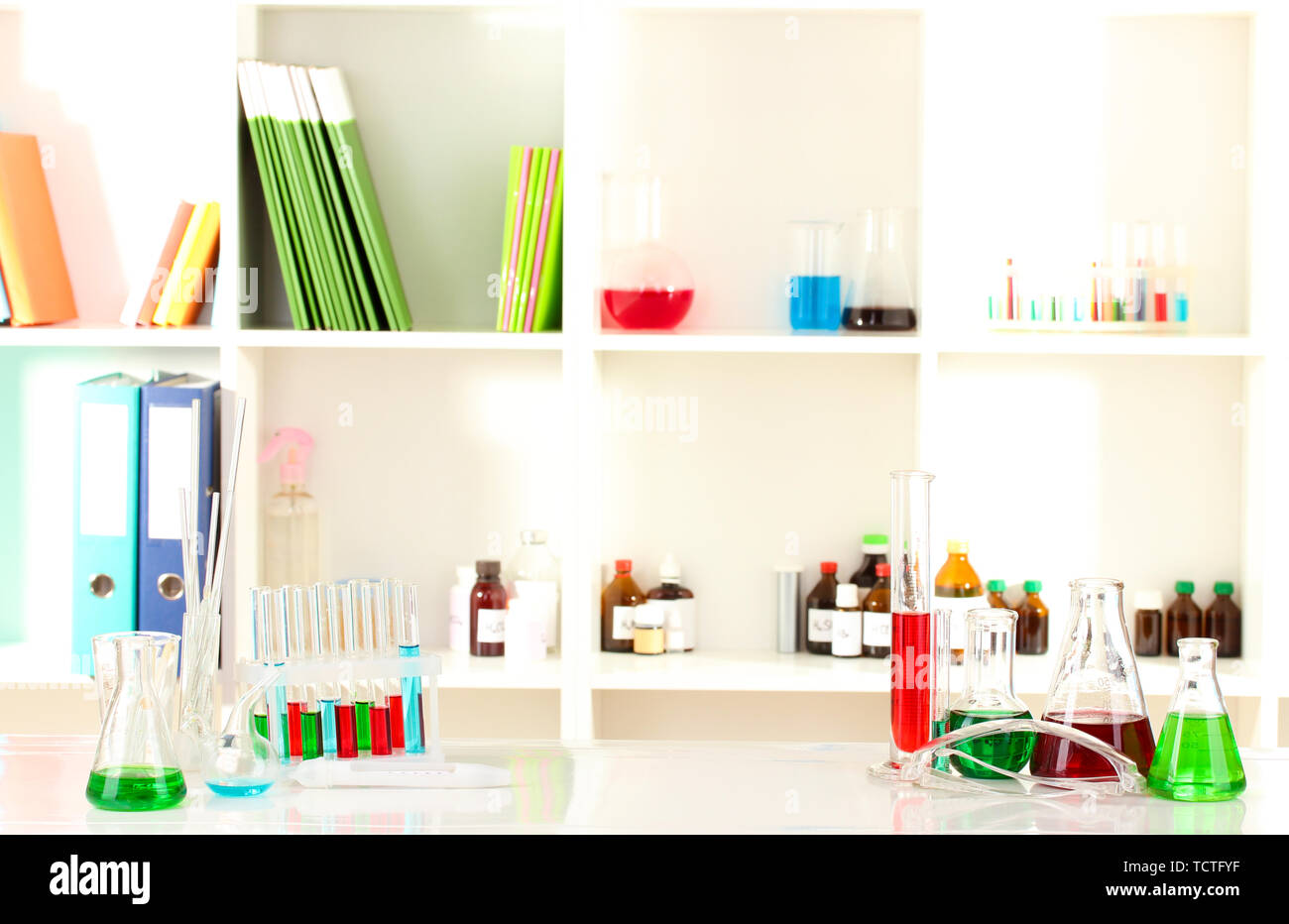 Different laboratory glassware with color liquid on laboratory ...