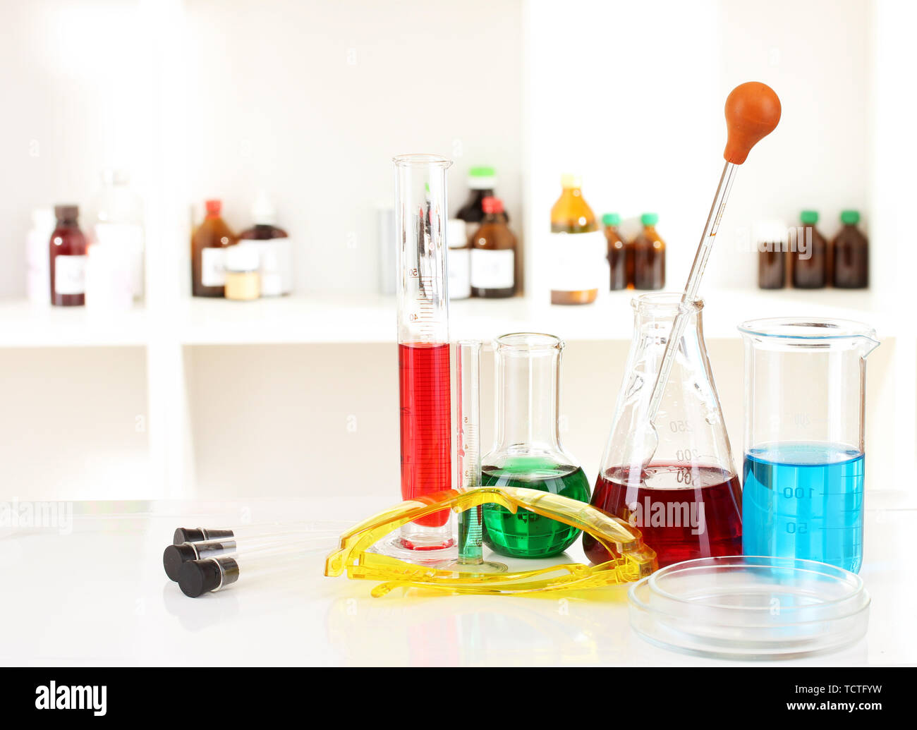 Different laboratory glassware with color liquid on laboratory ...