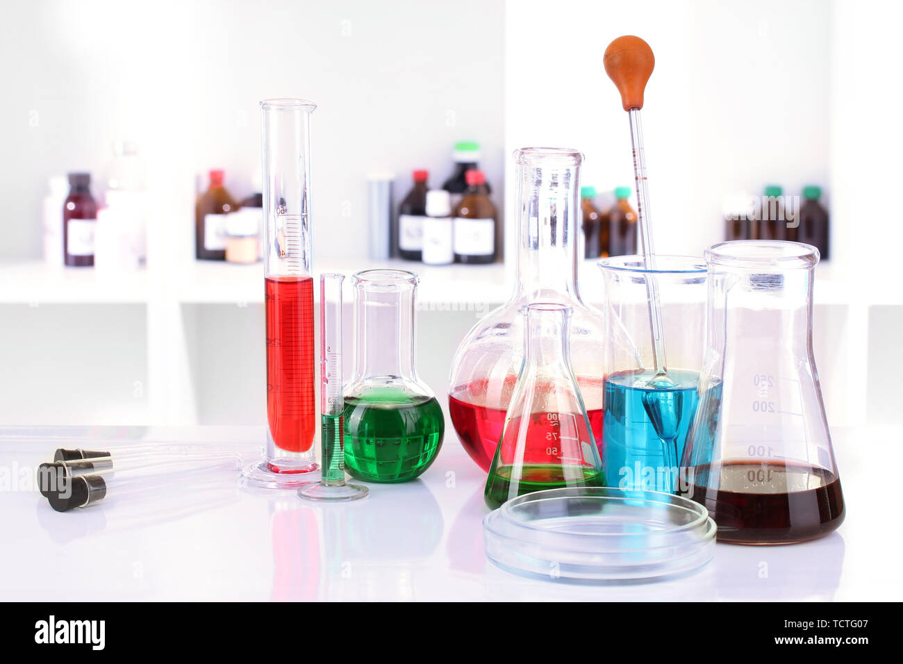 Different laboratory glassware with color liquid on laboratory ...