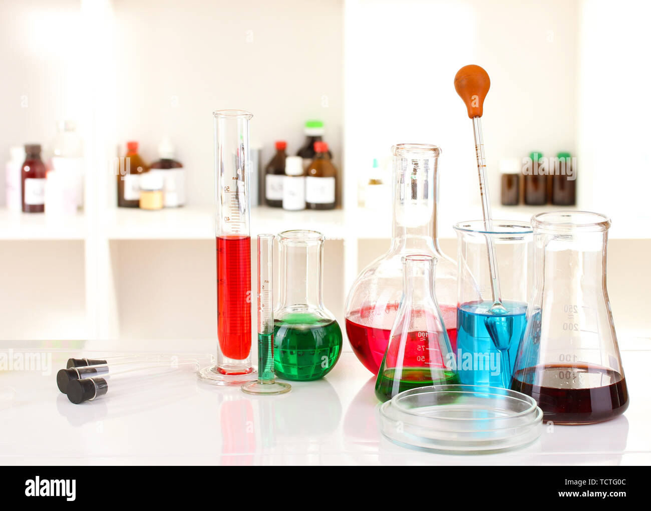 Different laboratory glassware with color liquid on laboratory ...