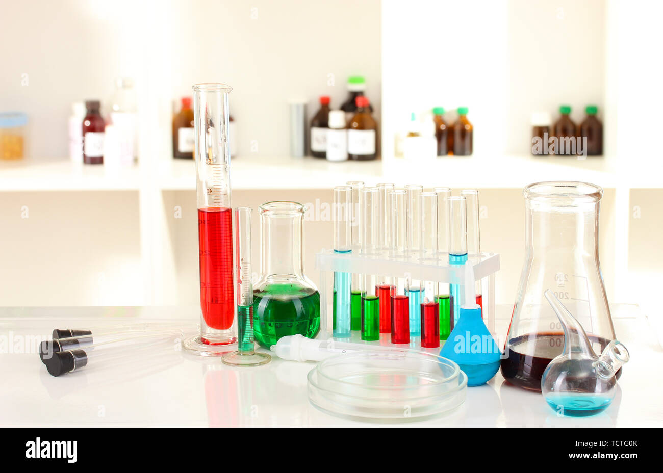 Different laboratory glassware with color liquid on laboratory ...