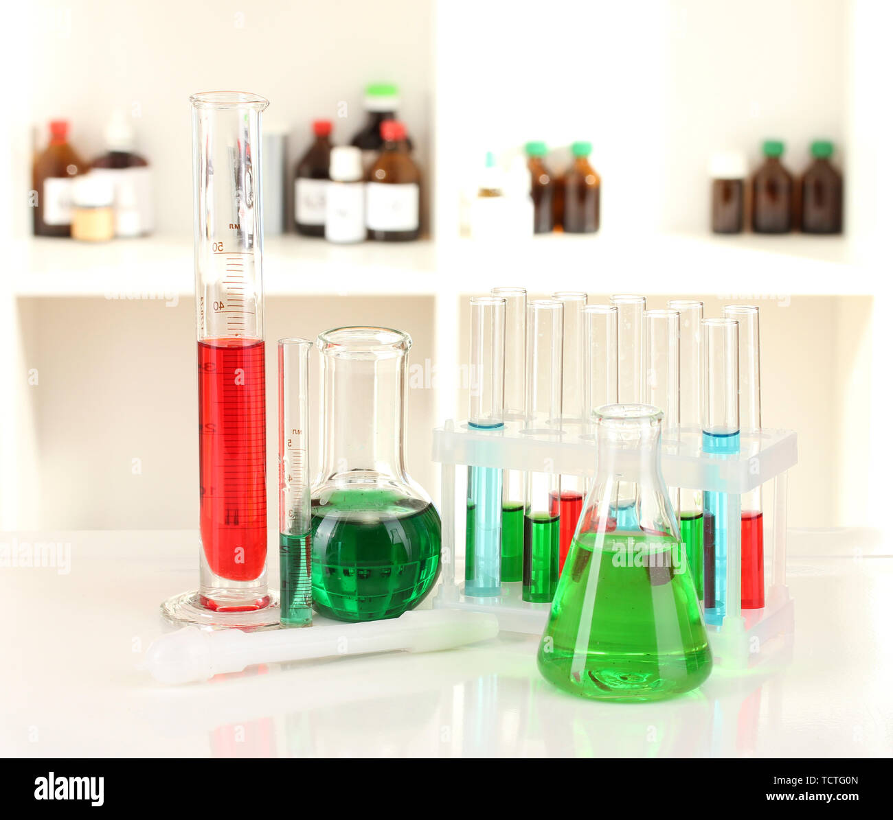 Different laboratory glassware with color liquid on laboratory ...
