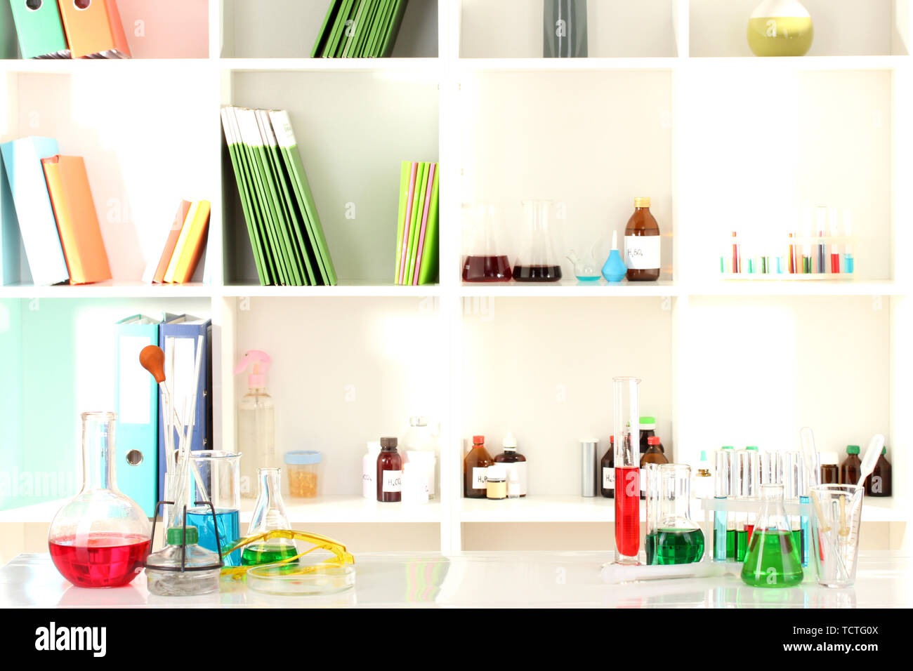 Different laboratory glassware with color liquid on laboratory ...