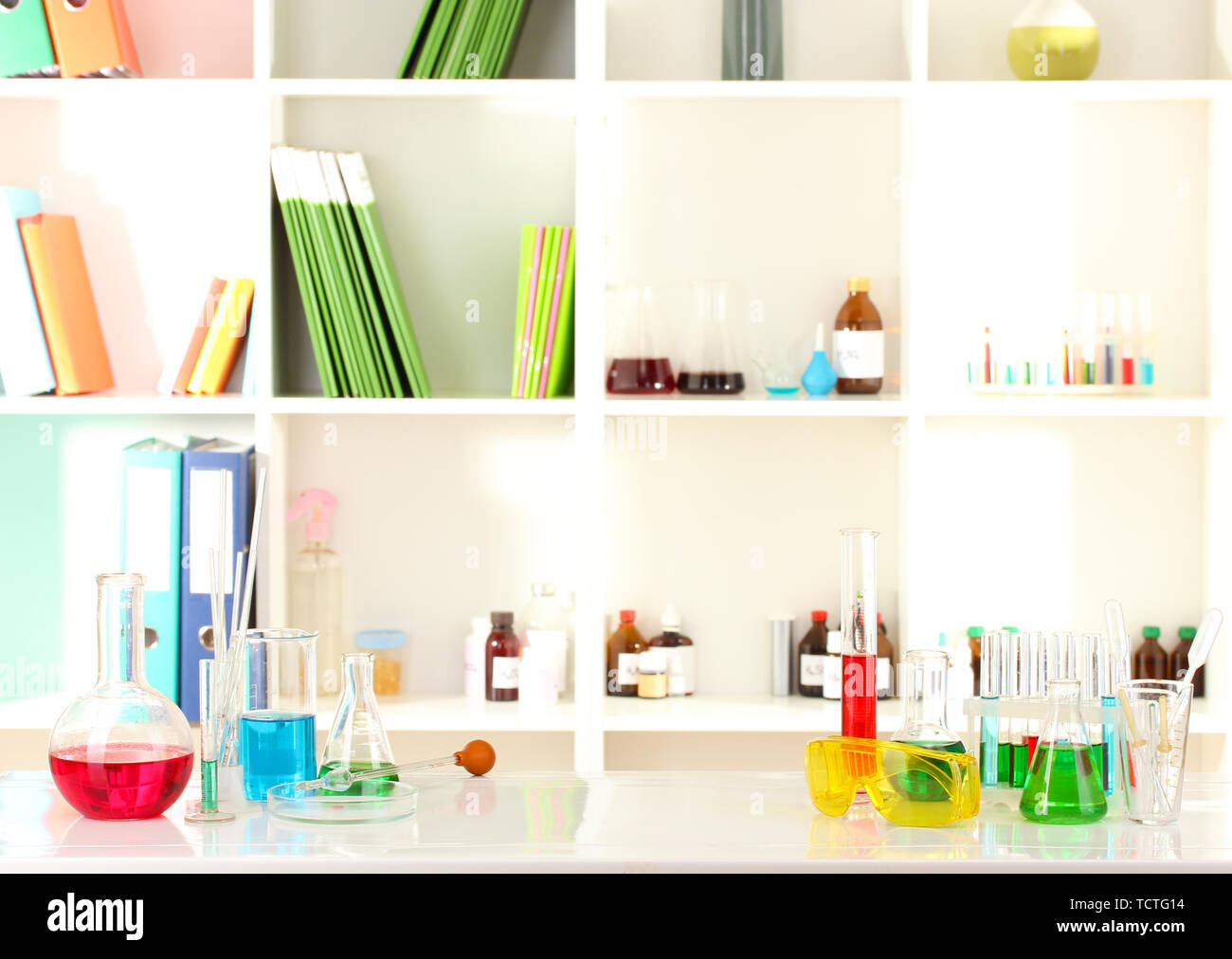 Different laboratory glassware with color liquid on laboratory ...