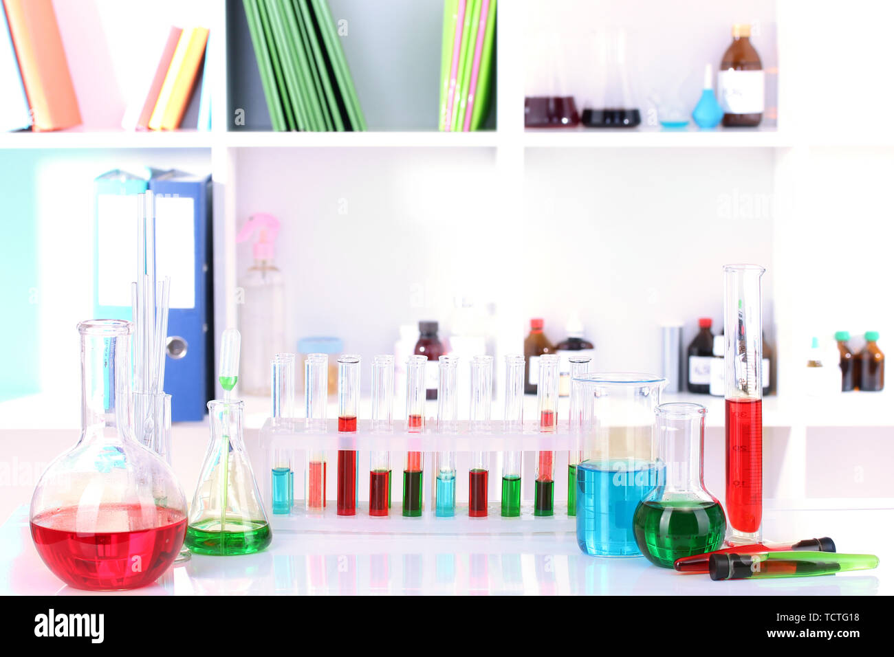 Different laboratory glassware with color liquid on laboratory ...