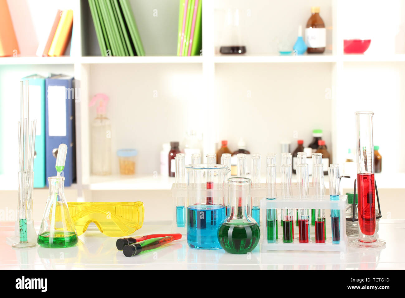 Different laboratory glassware with color liquid on laboratory ...