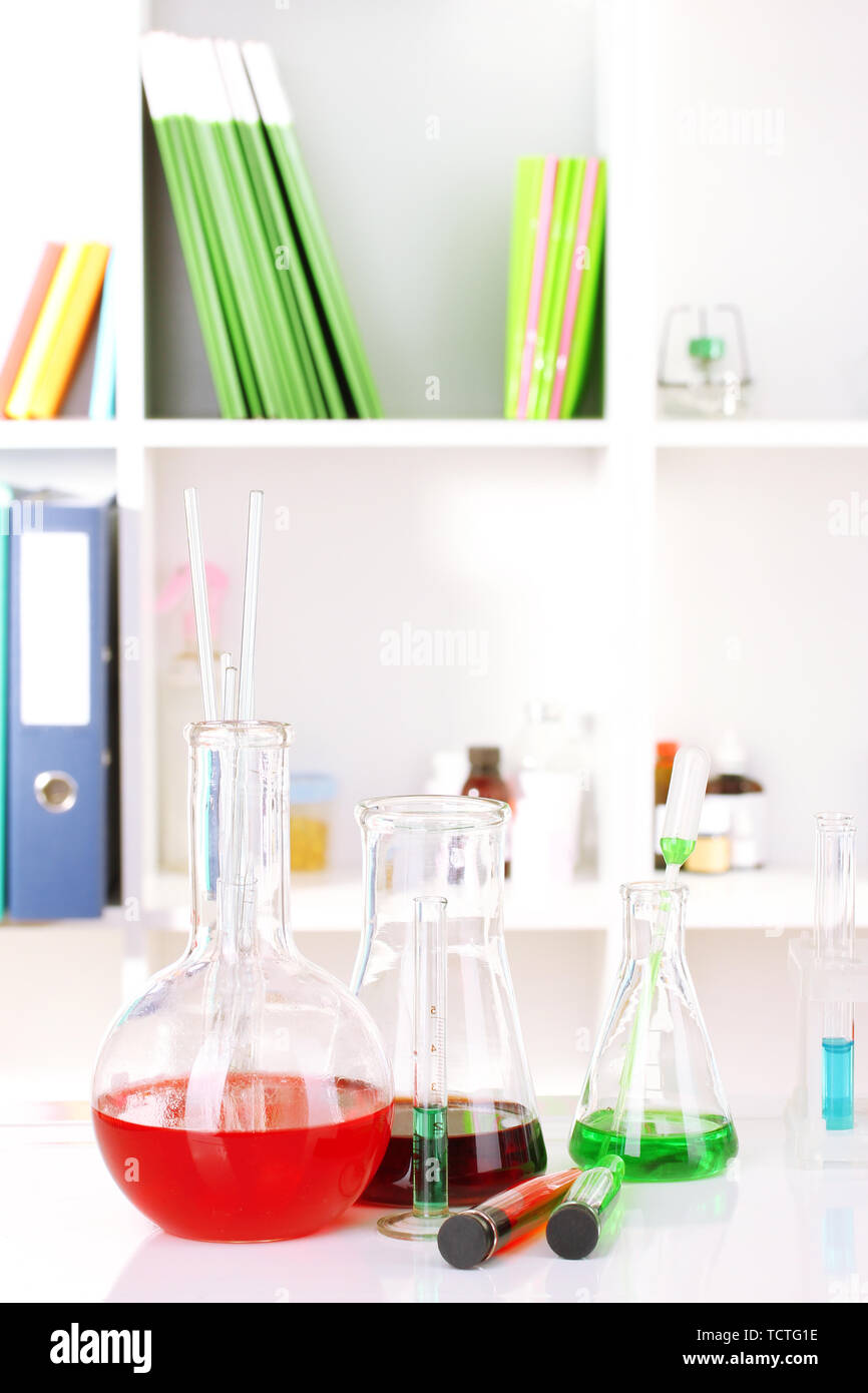 Different laboratory glassware with color liquid on laboratory ...