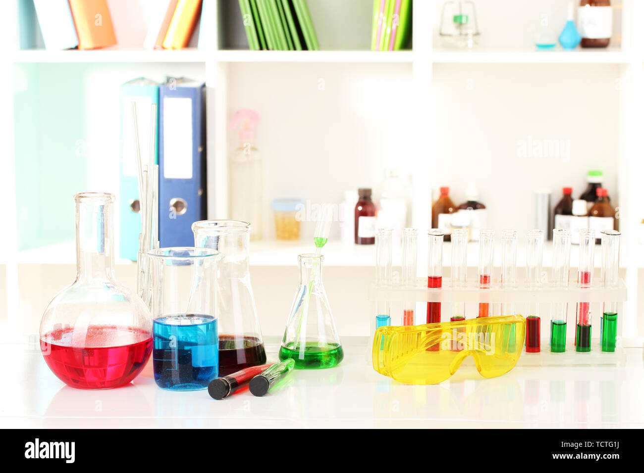 Different laboratory glassware with color liquid on laboratory ...
