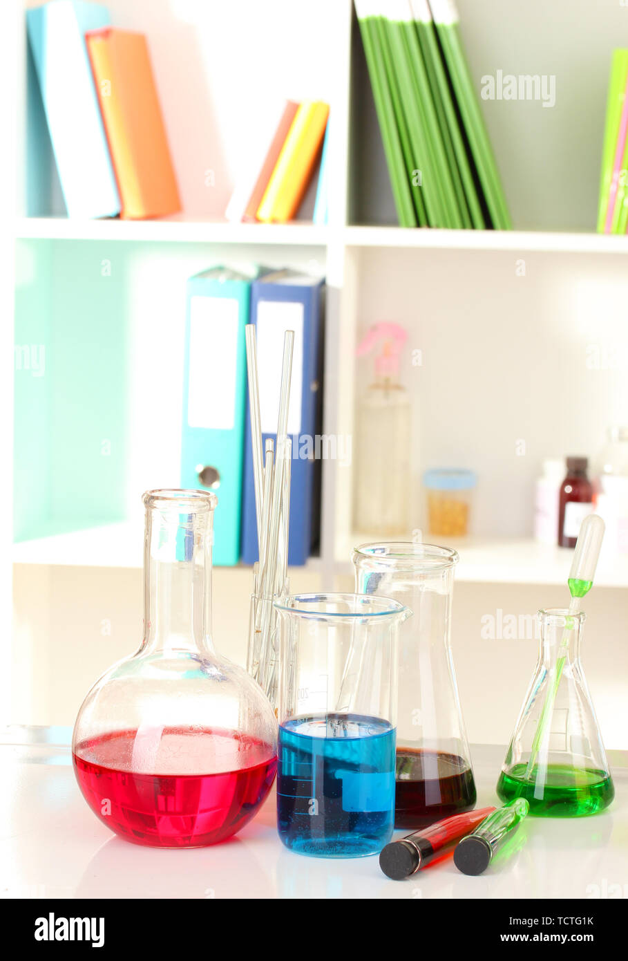 Different laboratory glassware with color liquid on laboratory ...