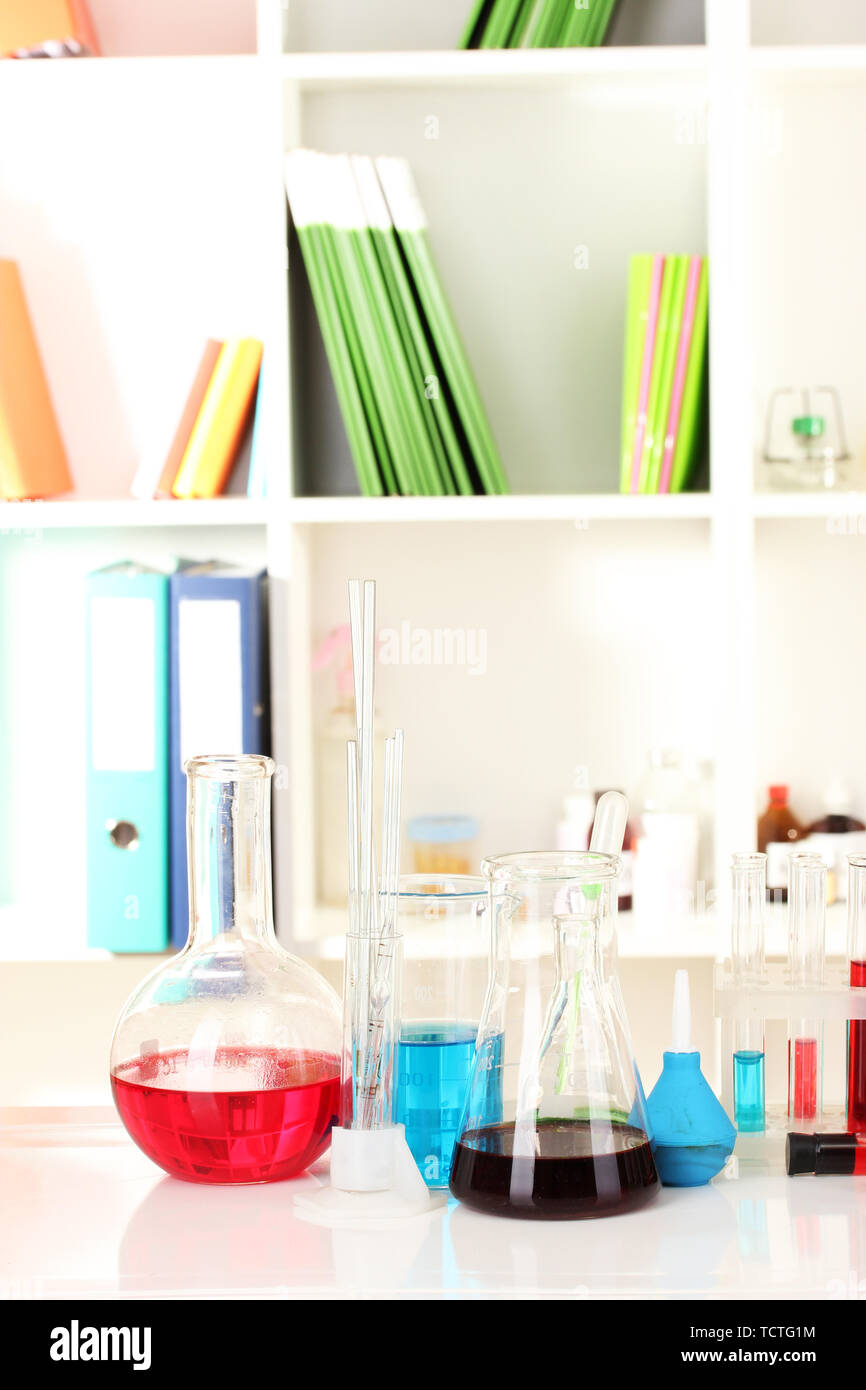 Different laboratory glassware with color liquid on laboratory ...