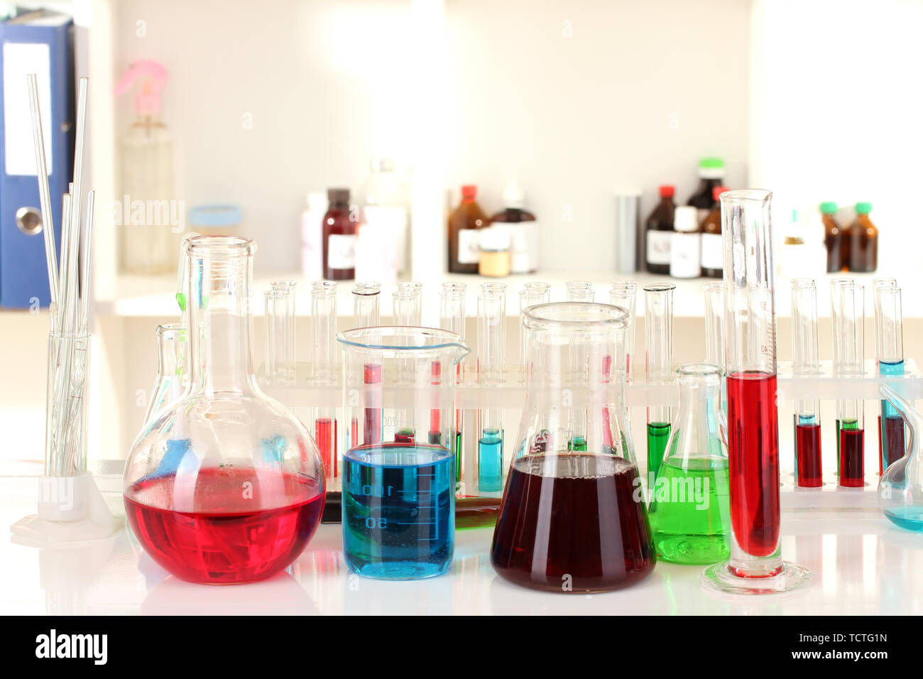 Different laboratory glassware with color liquid on laboratory ...