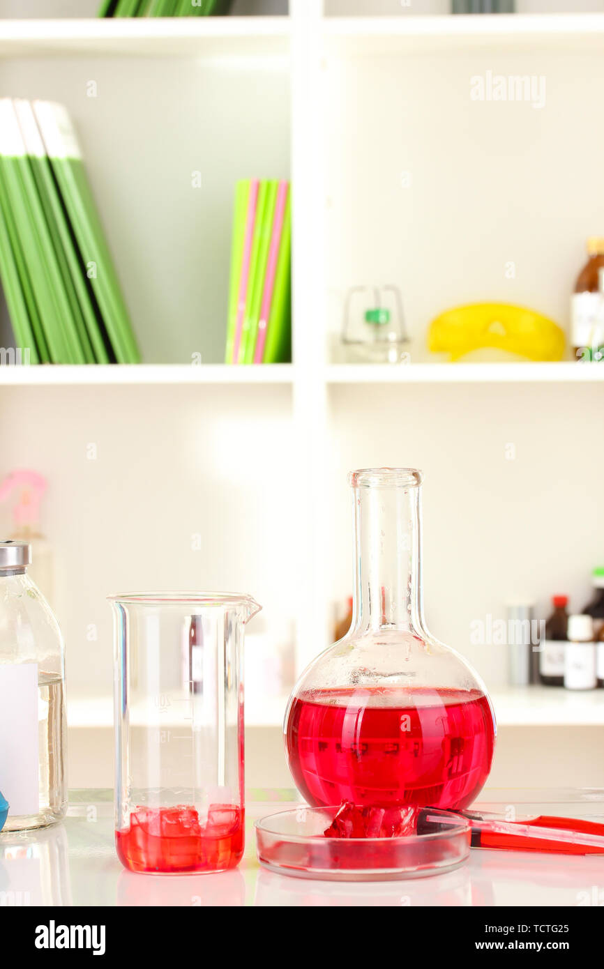 Different laboratory glassware with color liquid on laboratory ...