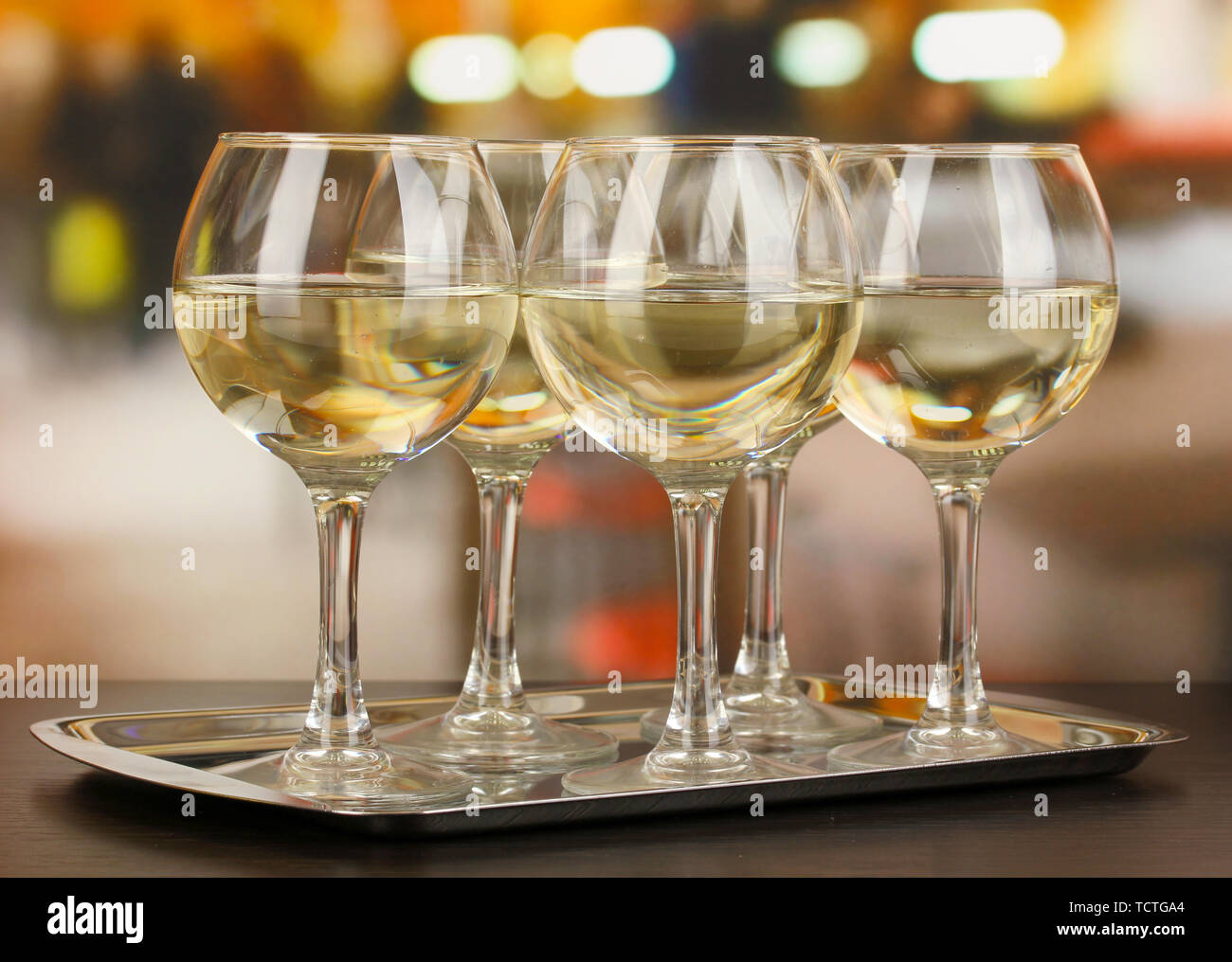White wine in glass on room background Stock Photo - Alamy