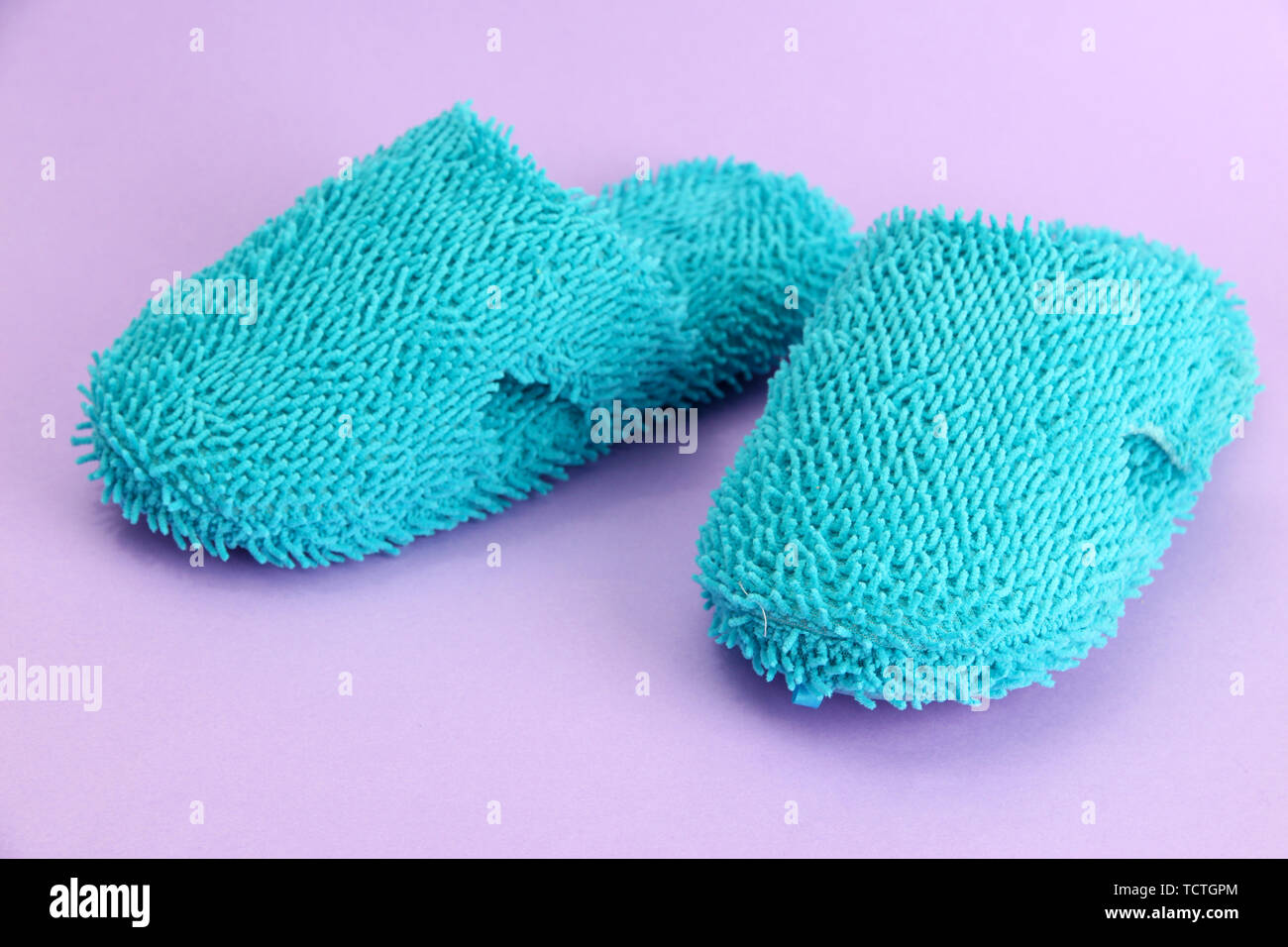 bright slippers, on purple background Stock Photo - Alamy