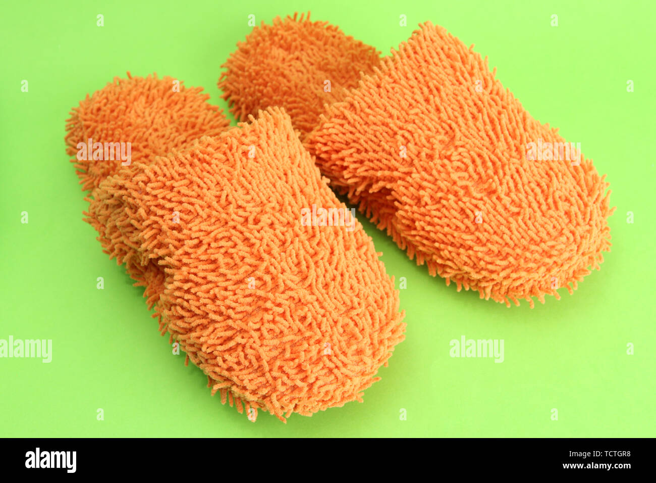 bright slippers, on green background Stock Photo - Alamy