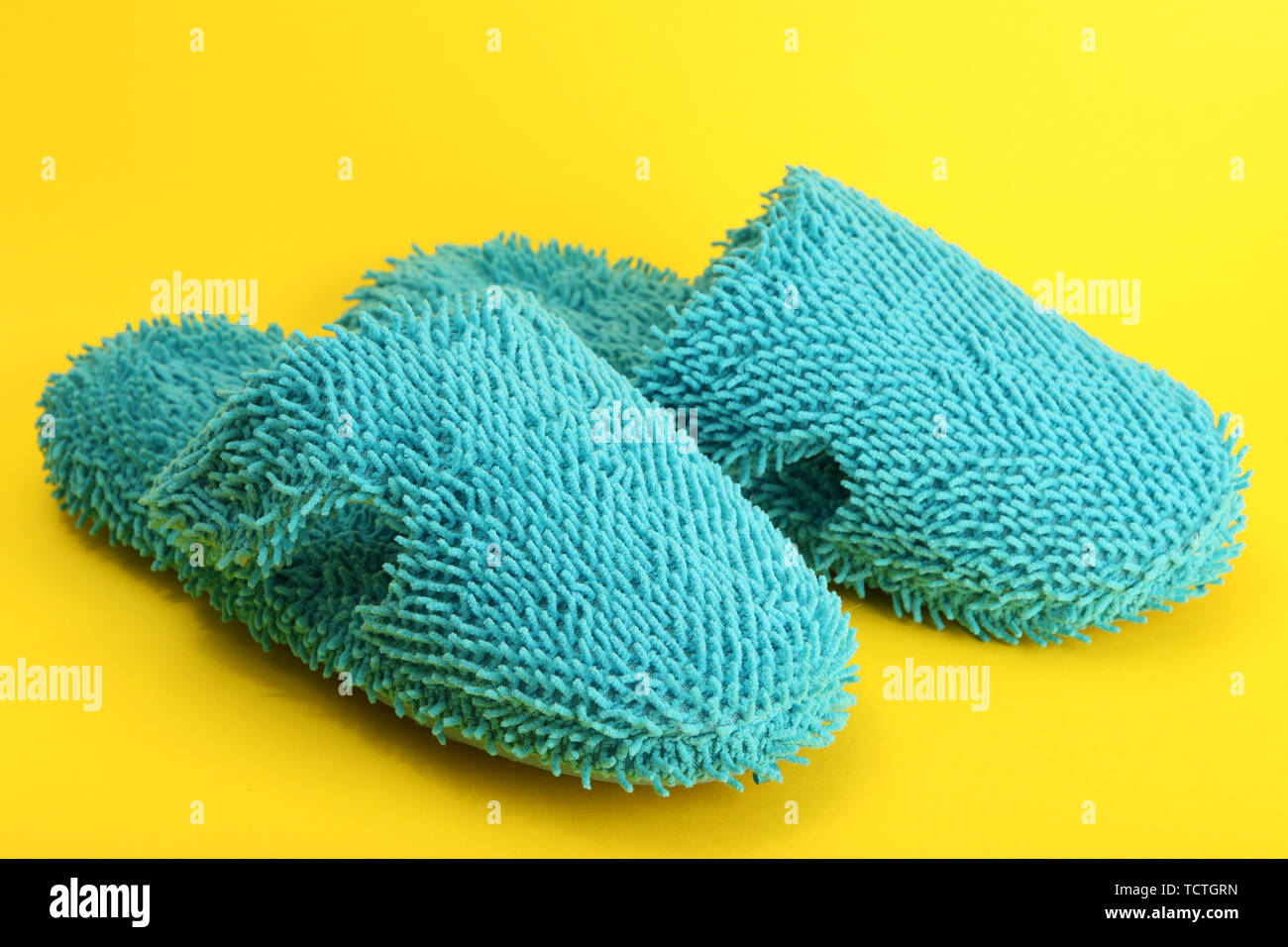 bright slippers, on yellow background Stock Photo - Alamy