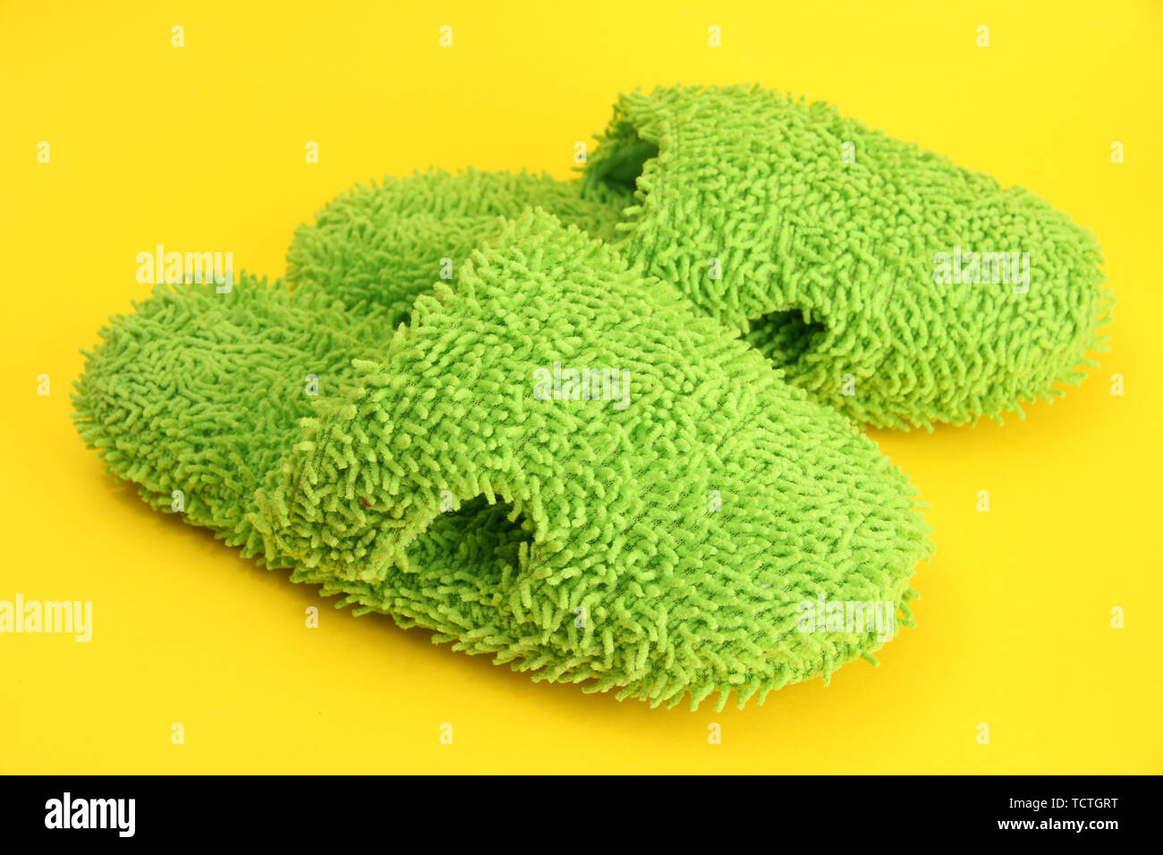 bright slippers, on yellow background Stock Photo - Alamy