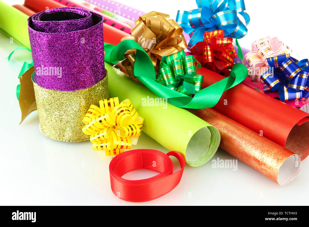 Rolls of Christmas wrapping paper with ribbons, bows isolated on white ...