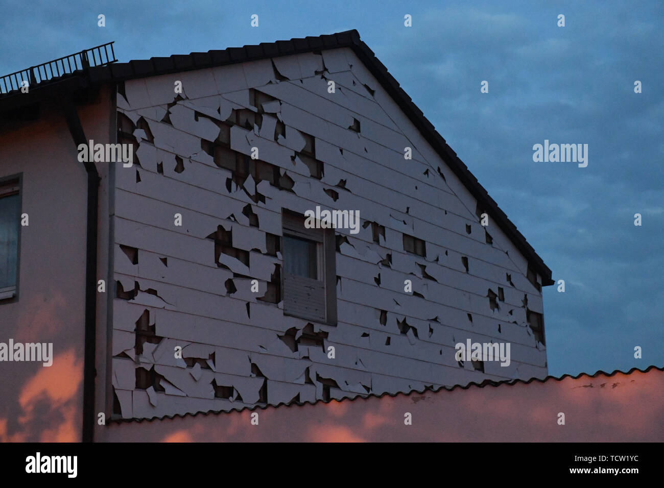 Germering, Germany. 10th June, 2019. A cladding of a house wall damaged ...