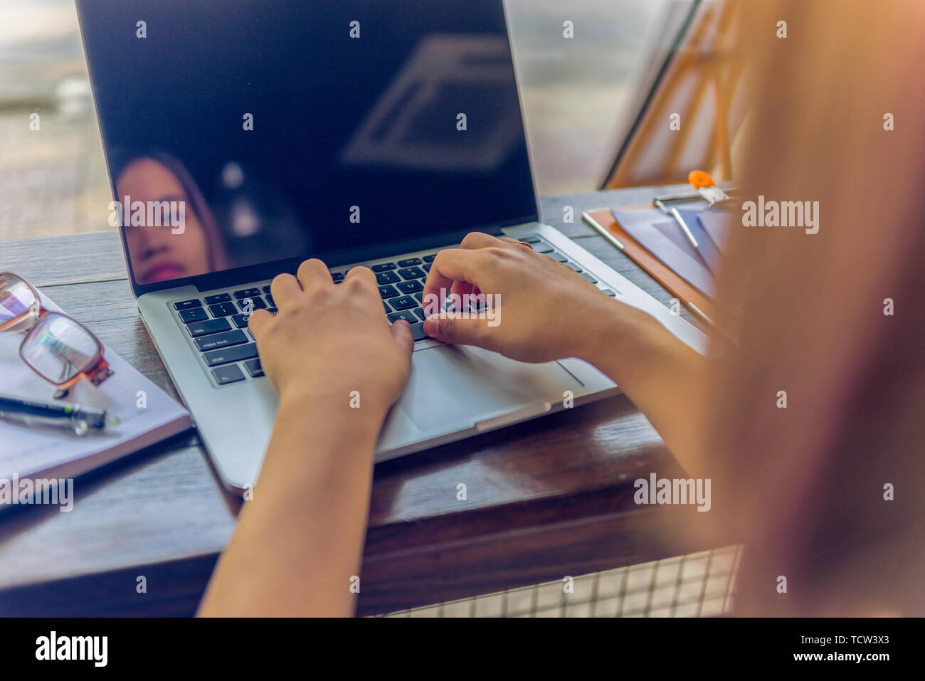 Rear view of millennial woman typing laptop keyboard Stock Photo - Alamy