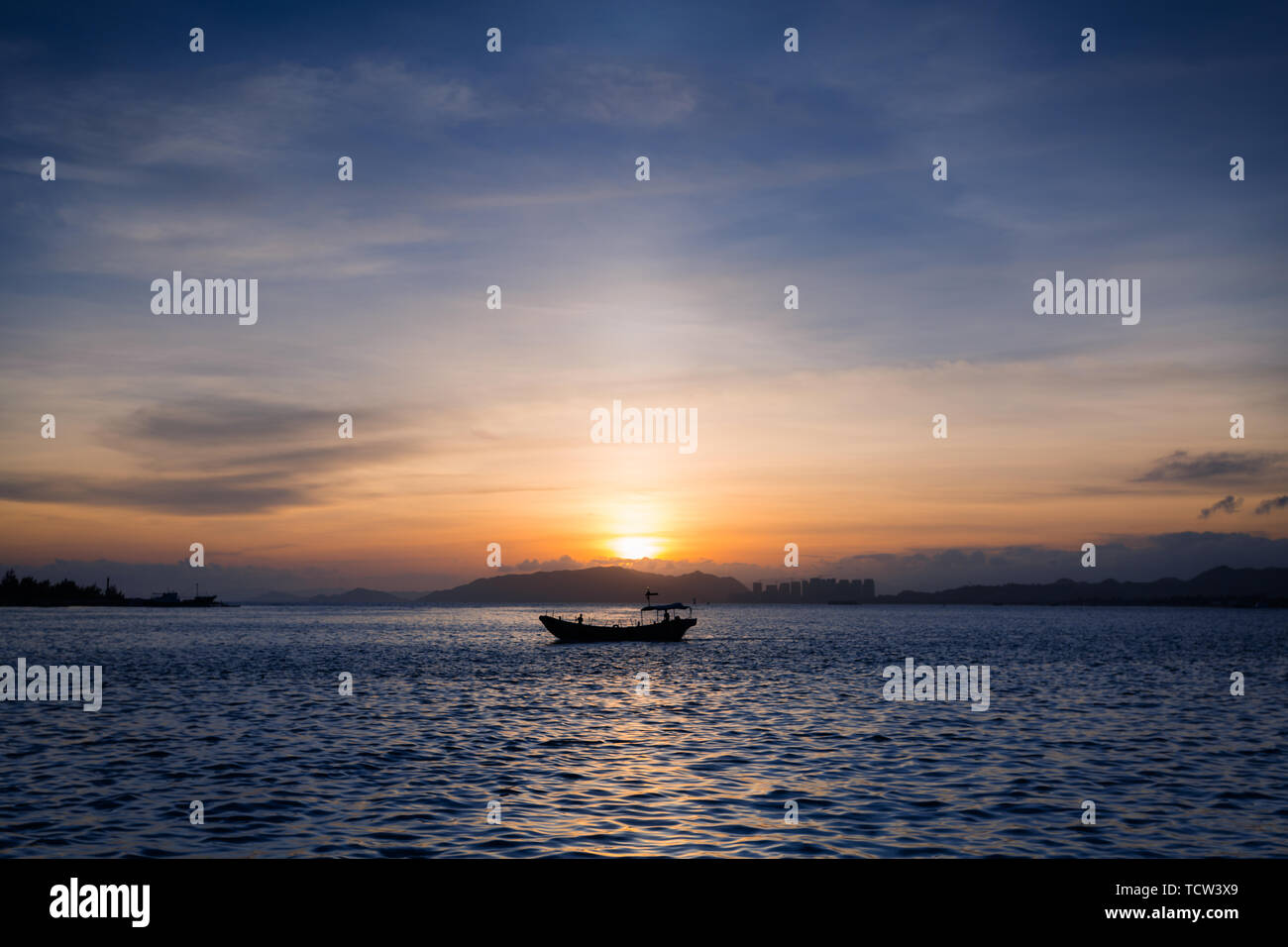 Sea blue sky sunset dusk background boat Stock Photo - Alamy
