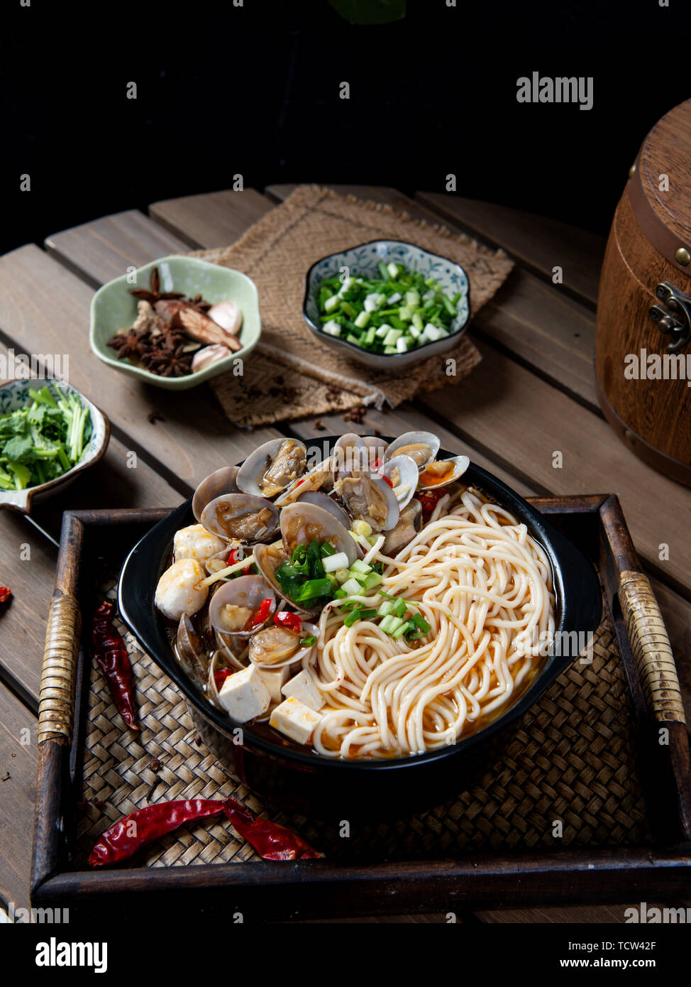 Golden soup, spicy flower armor, pink noodles Stock Photo - Alamy