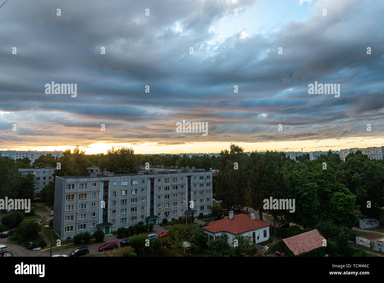 dramatic dark red clouds in sunset over countryside fields and forests ...