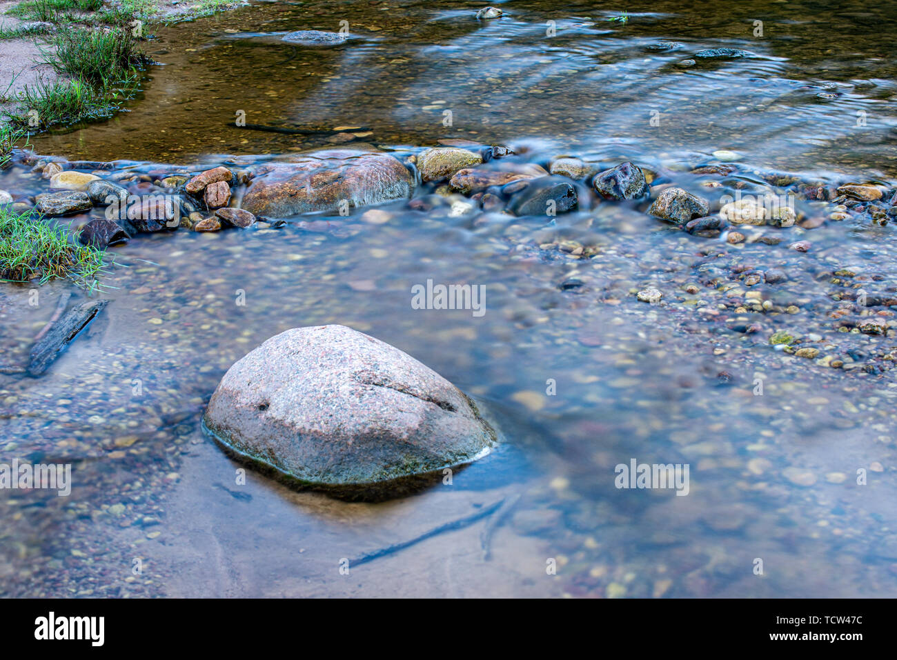water texture with reflections and rocks on the bottom of stream ...