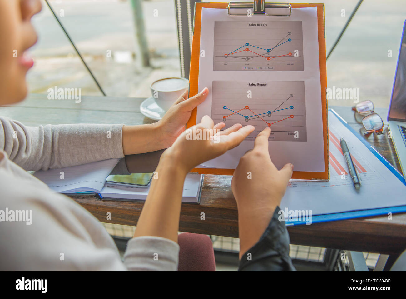 Close up of women hands pointing at graph sales report data Stock Photo ...