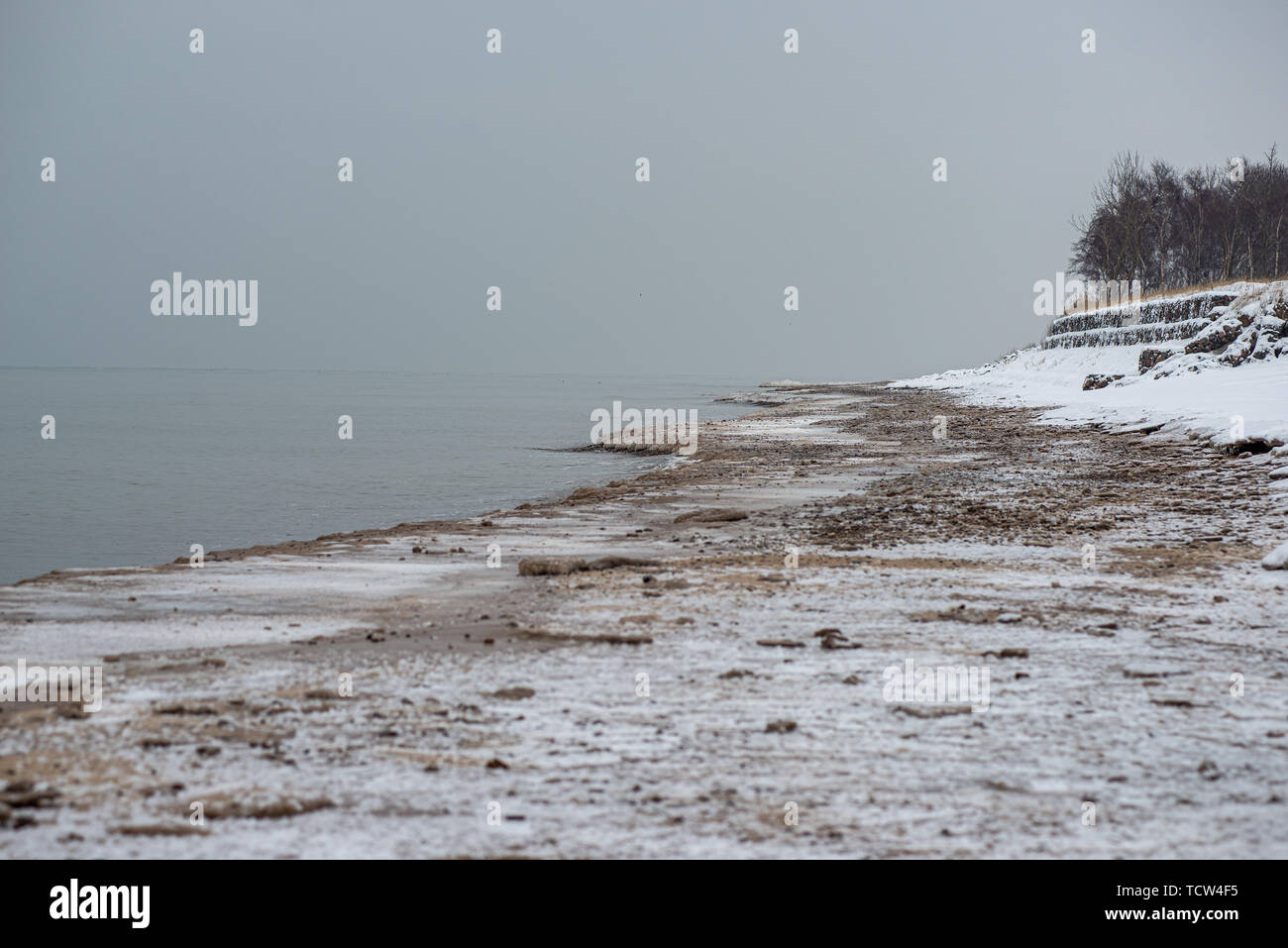 pieces of frozen ice in the lake in dim winter day under snow Stock ...