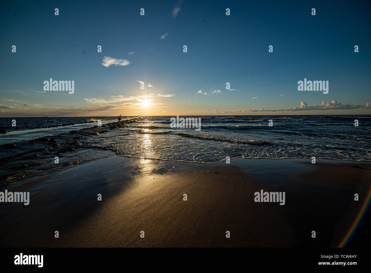 dramatic dark red clouds in sunset over countryside fields and forests ...