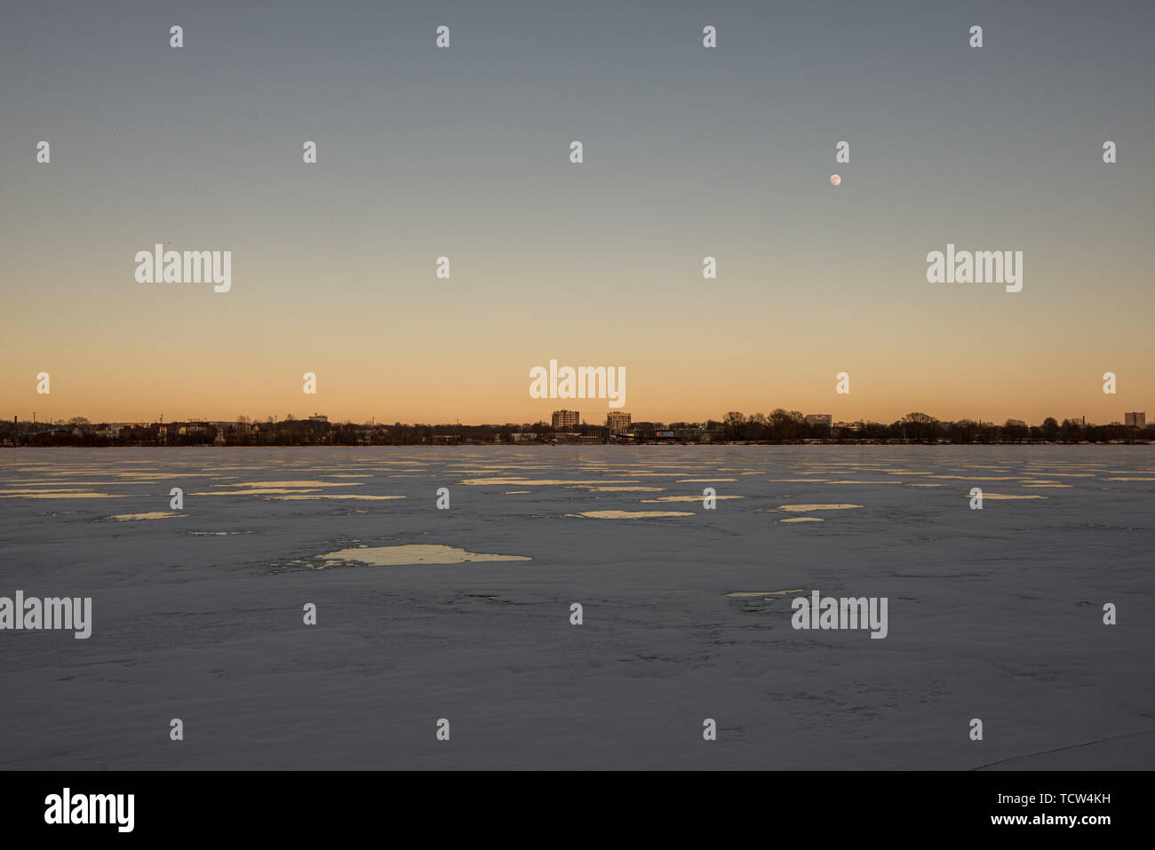 pieces of frozen ice in the lake in dim winter day under snow Stock ...