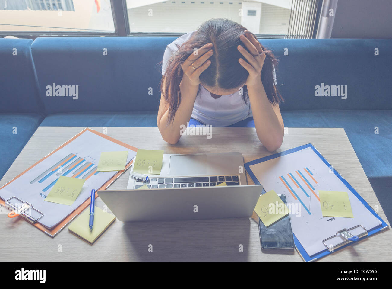 Woman freelancer headache paperwork hi-res stock photography and images ...