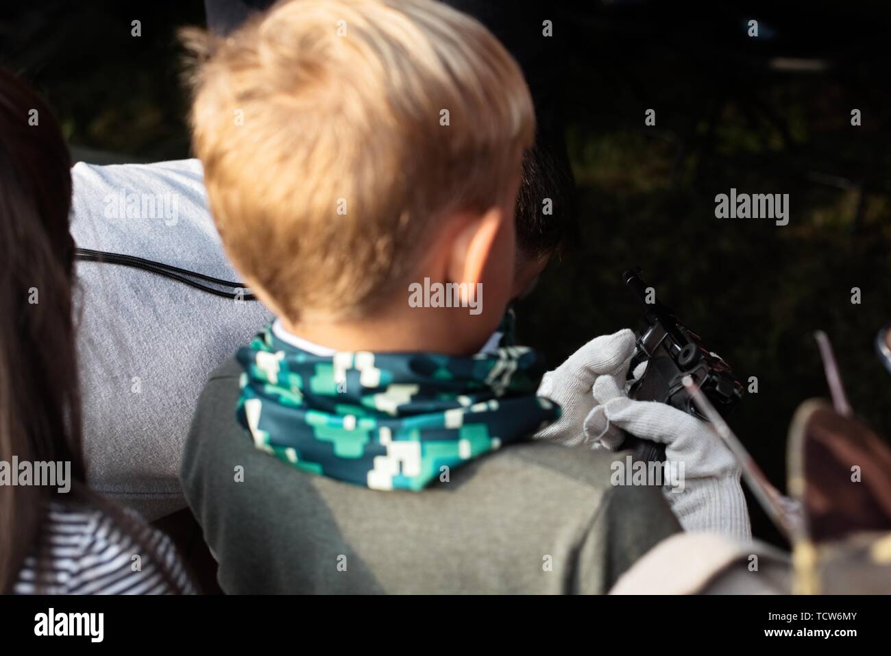 A boy with gun. Little boy holding real gun in the hand. Happy boy with ...