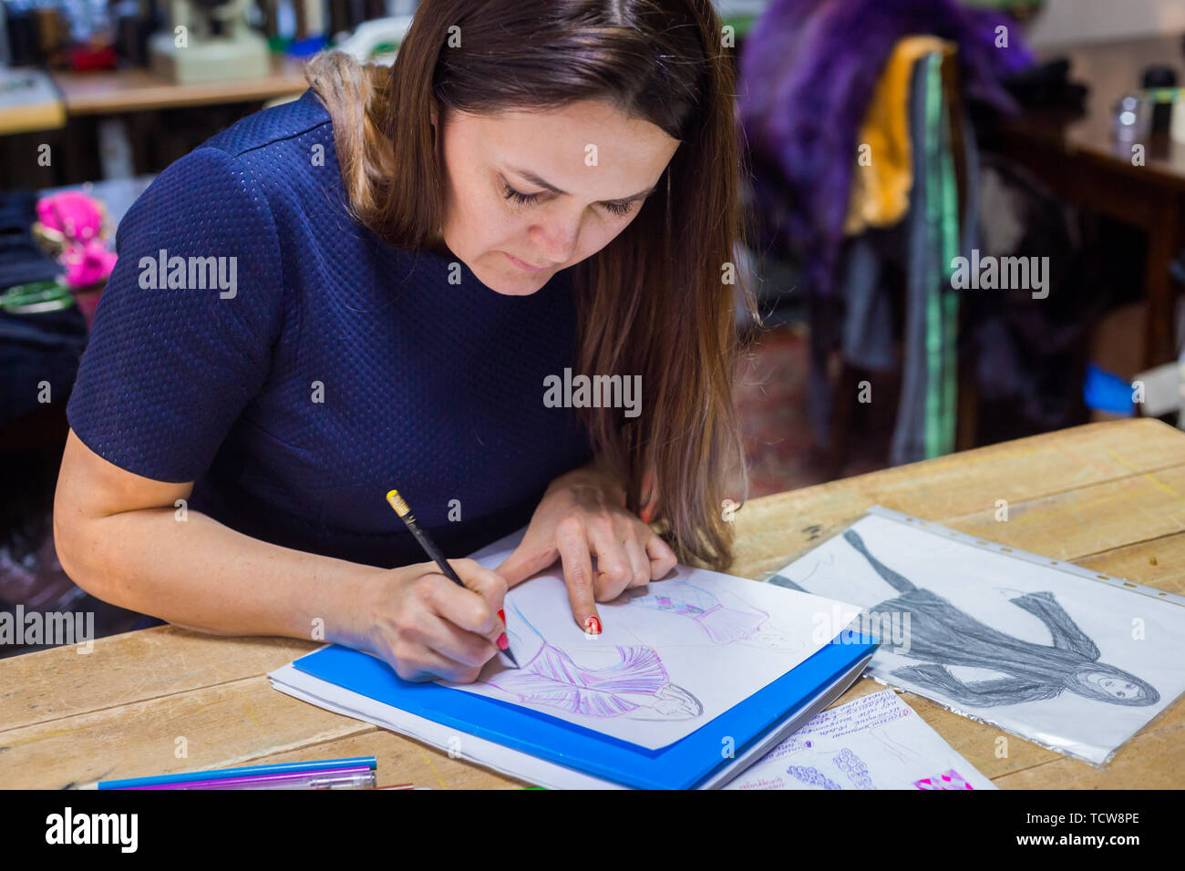 Fashion designer drawing design sketch Stock Photo - Alamy