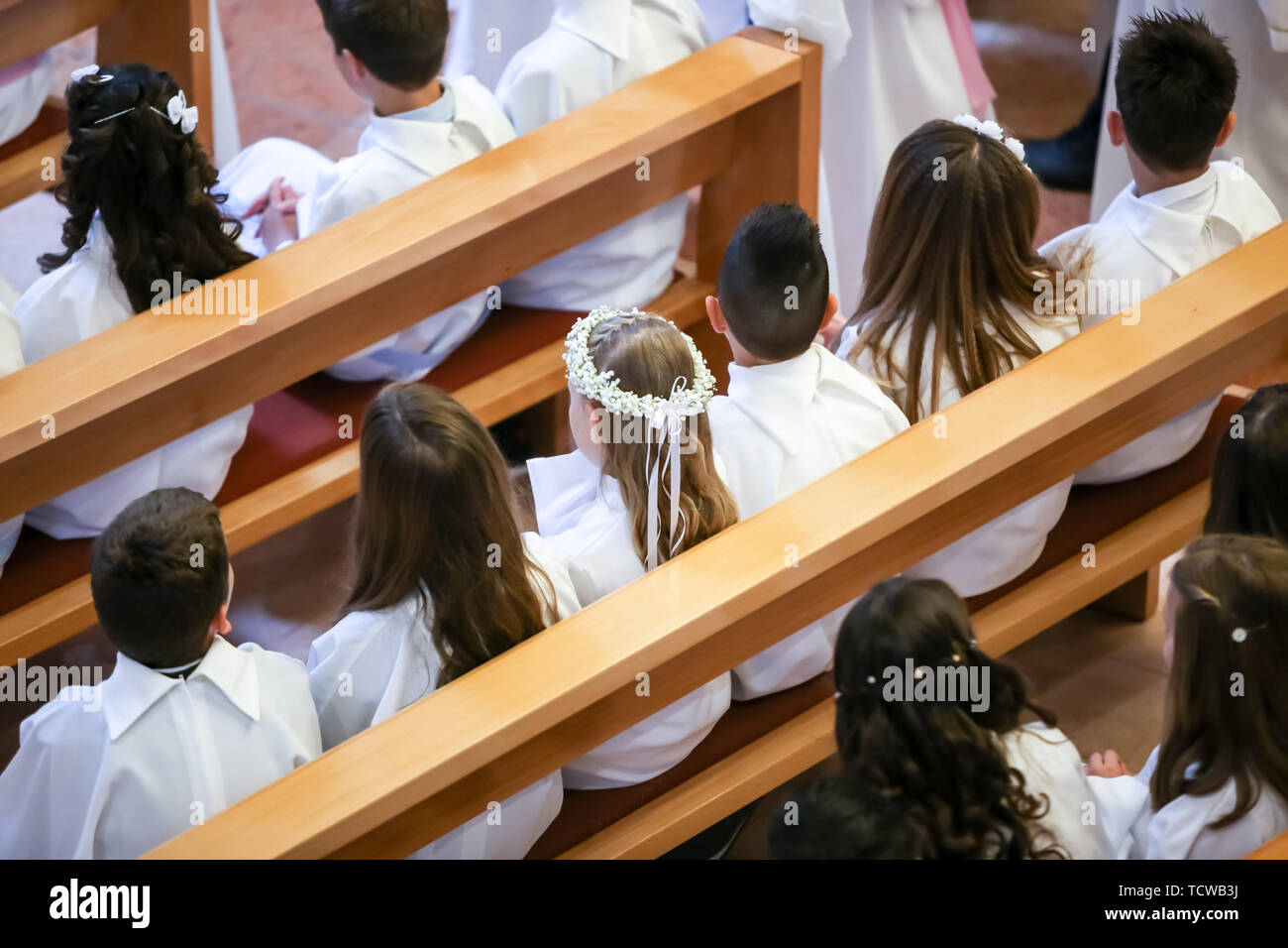 Children on the first holy communion in the church. View from above of ...