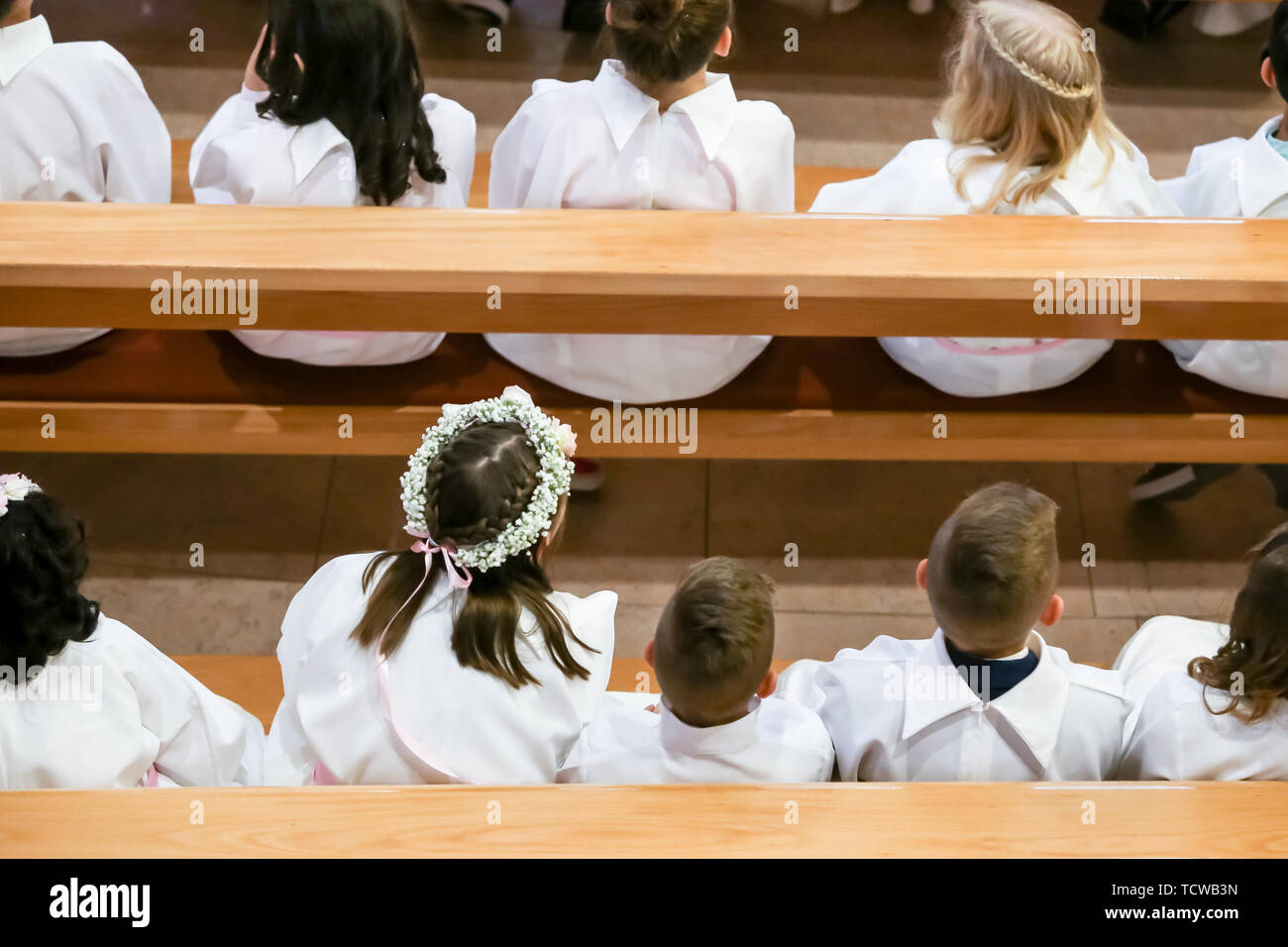 Children on the first holy communion in the church. View from above of ...