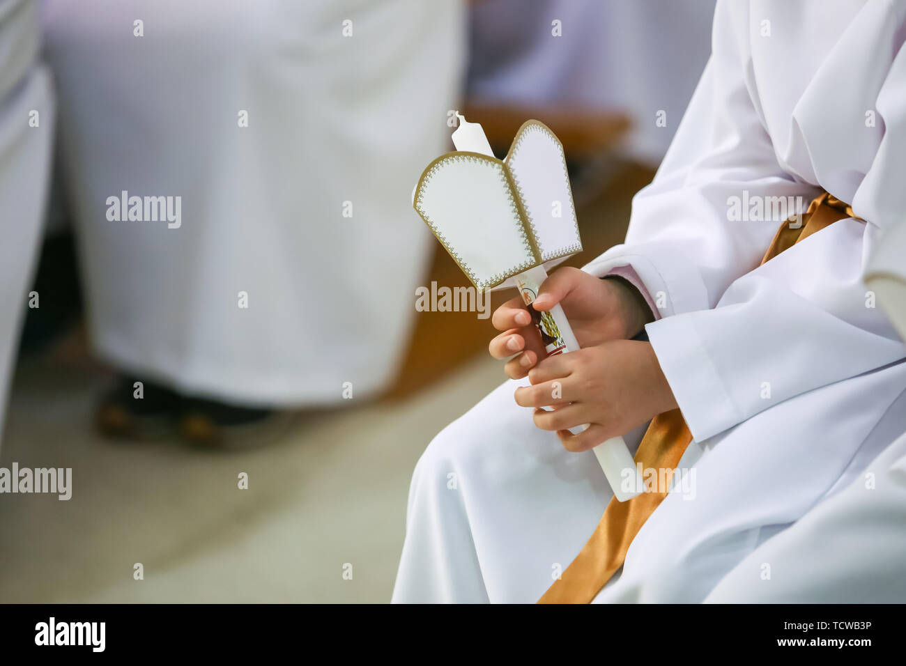 Children on the first holy communion in the church. Detail of the ...