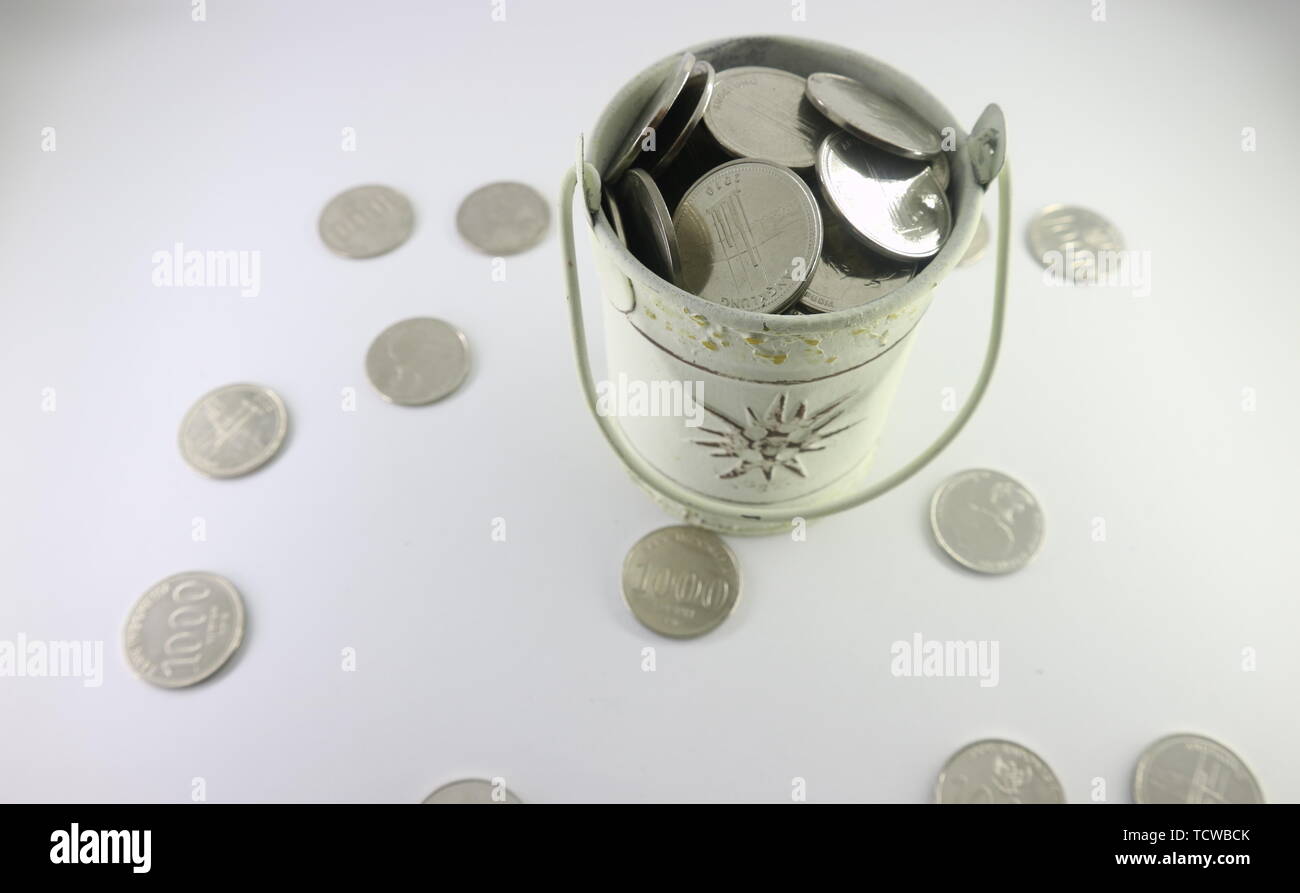coin on the white bucket isolated on white background Stock Photo - Alamy