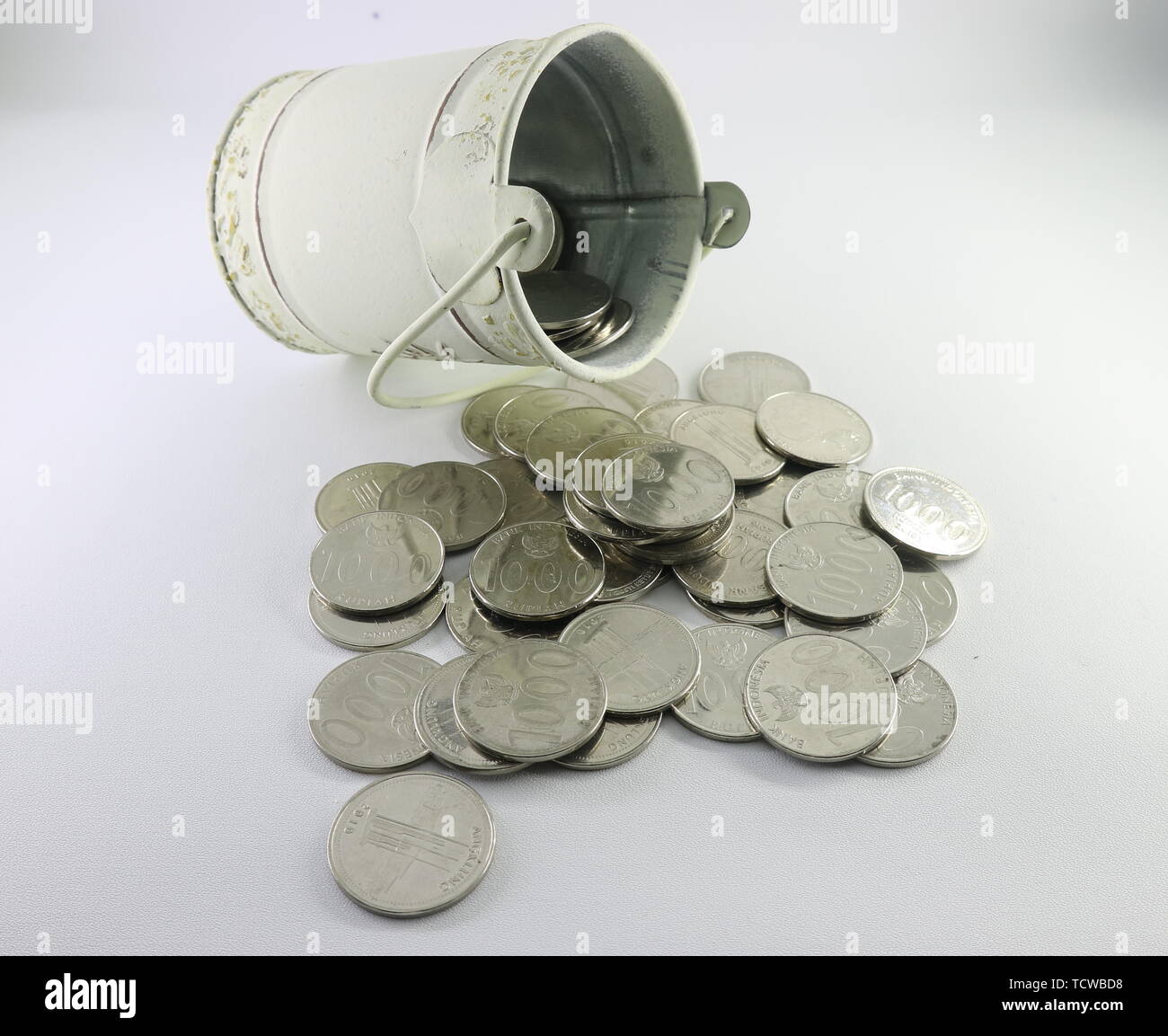 coin on the white bucket isolated on white background Stock Photo - Alamy