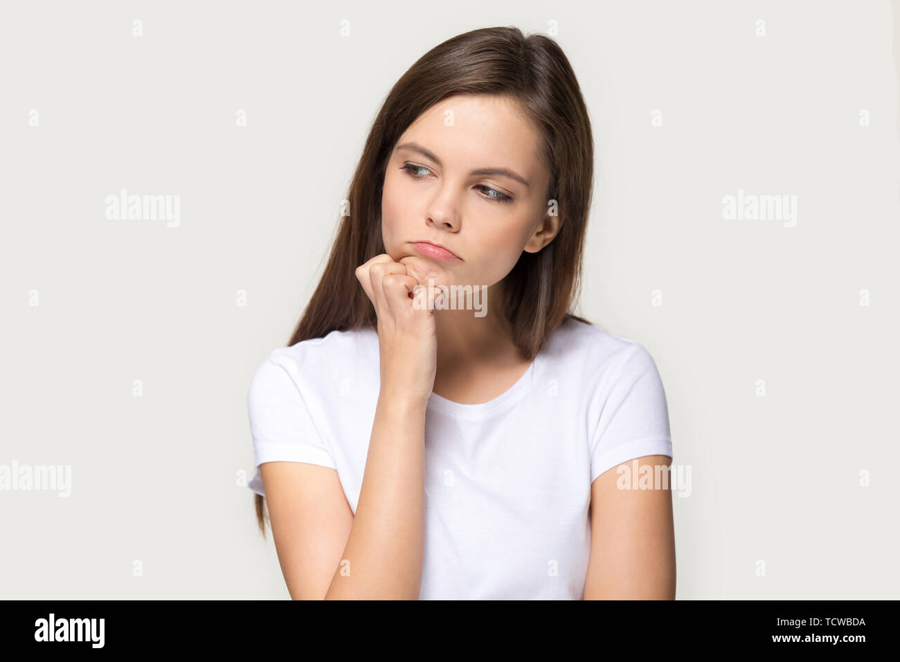 Millennial sad pensive woman feels upset isolated on grey background ...