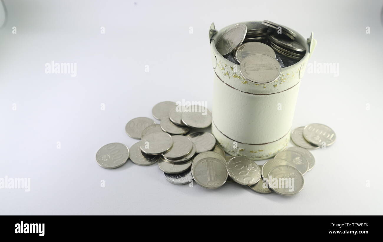 coin on the white bucket isolated on white background Stock Photo - Alamy