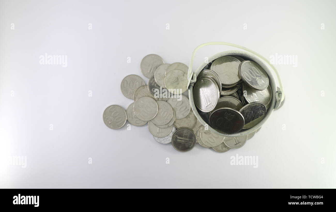 coin on the white bucket isolated on white background Stock Photo - Alamy