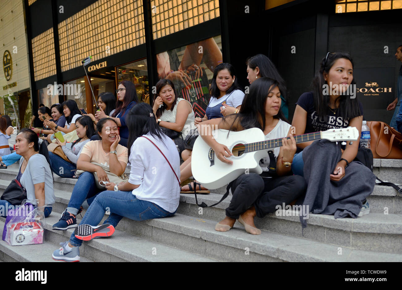 singapore - 2018.02.25: philippine maids spending time during their ...