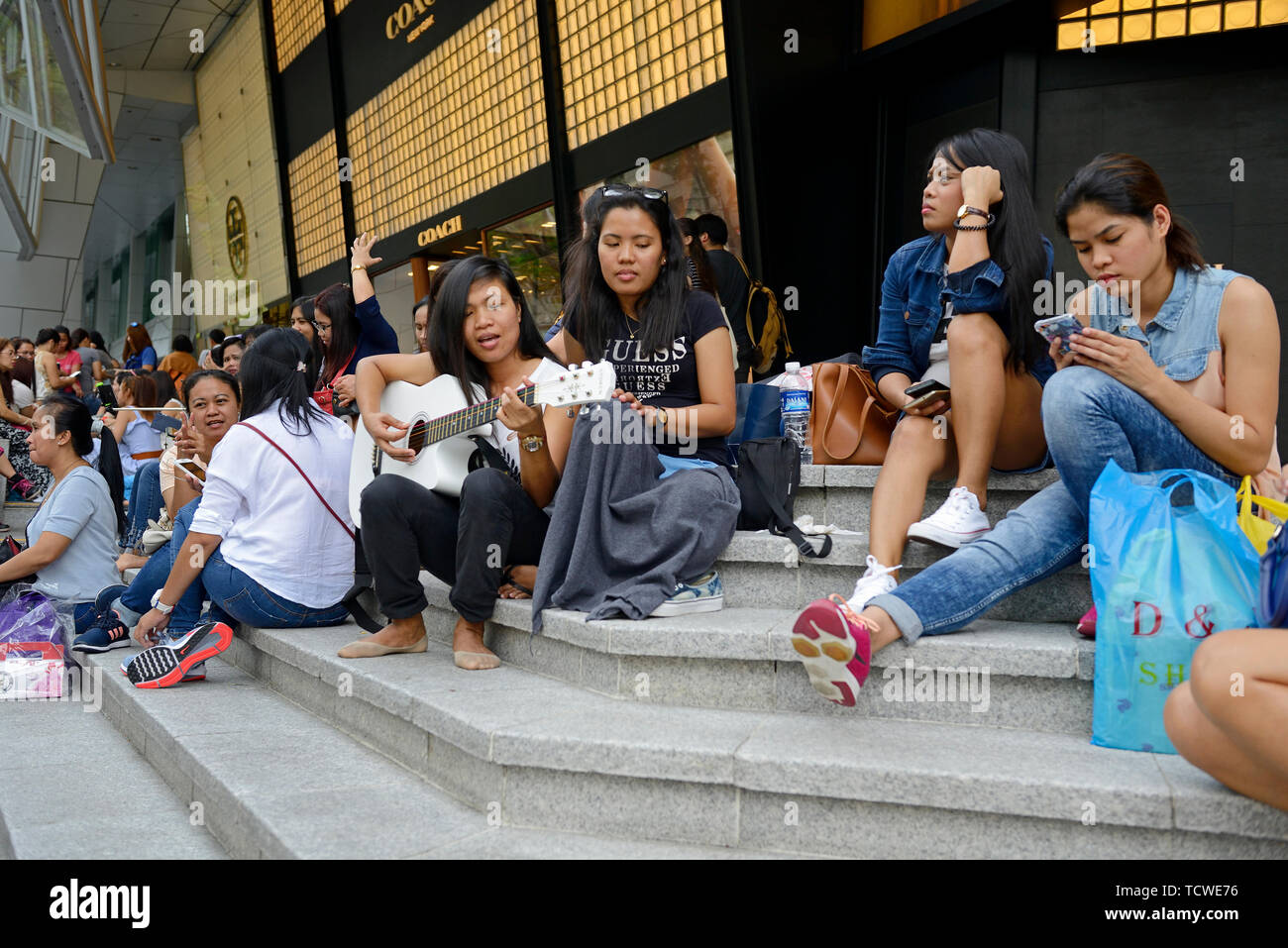 singapore - 2018.02.25: philippine maids spending time during their ...
